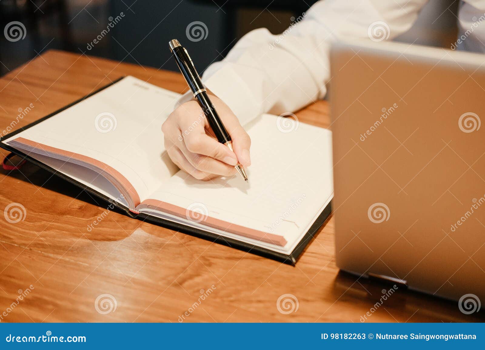 Hand of Businessman Hold Pen Write on Notebook. Computer Notebook ...