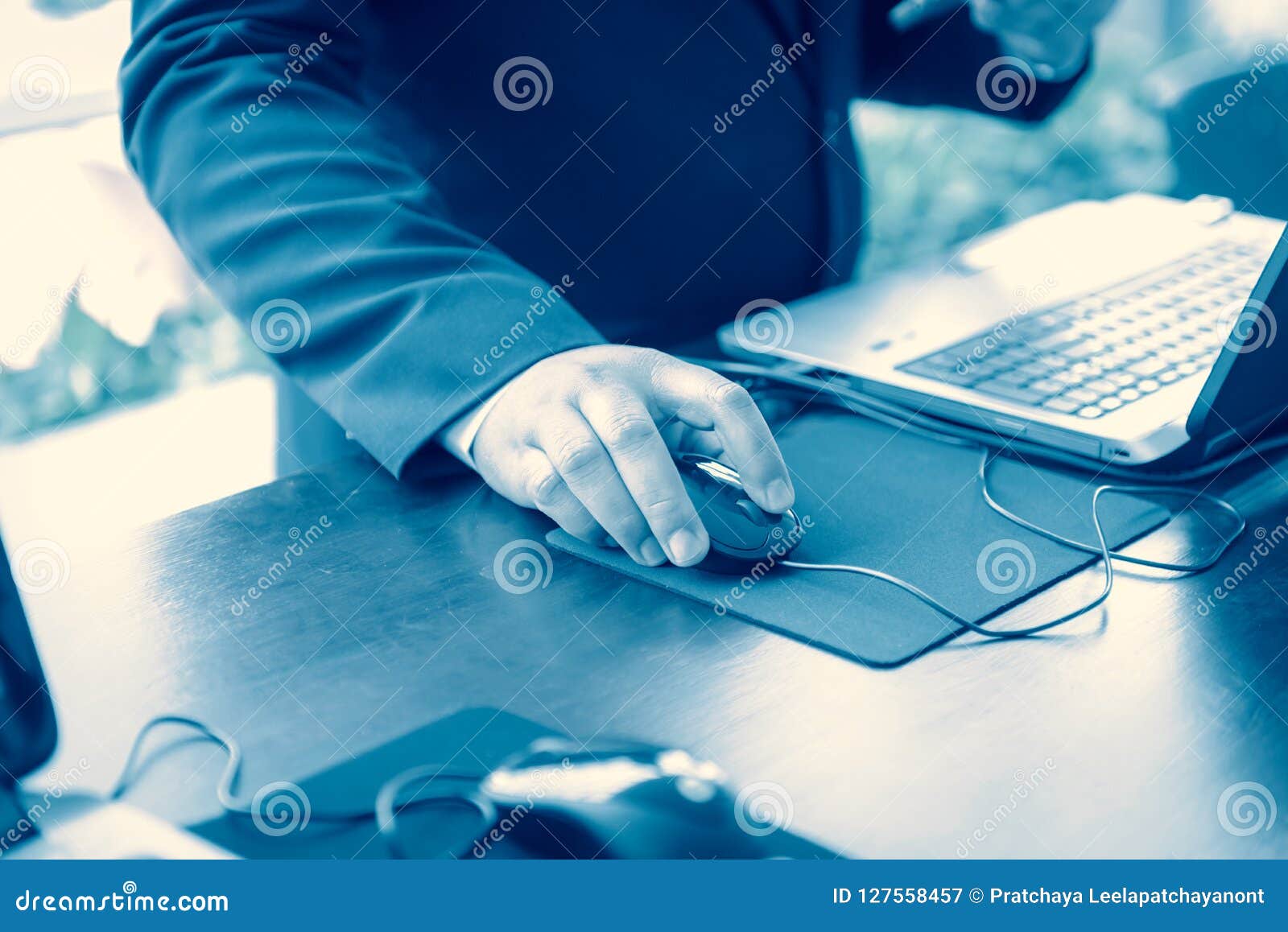 Hand of Businessman Touching a Computer Mouse with Laptop Computer ...