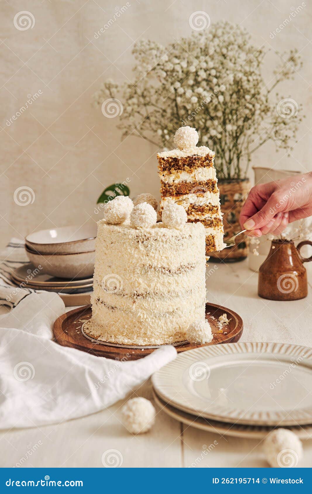 Hand with a Cake Server Picking Up Cut Slice of Round White Cake with ...
