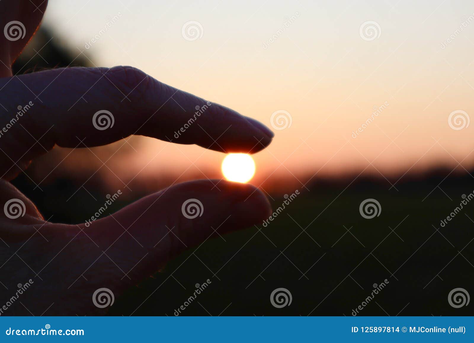 Hand Capturing the Sun stock photo. Image of sunset - 125897814