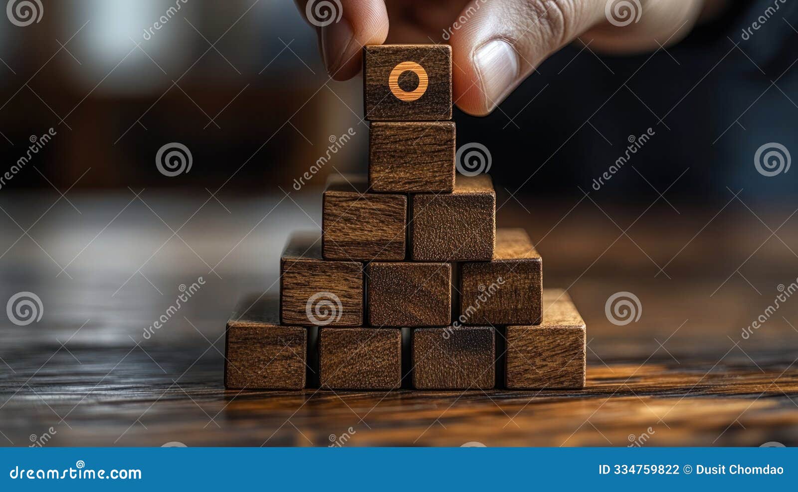 A Hand Carefully Places Final Wooden Block on Pyramid Structure ...