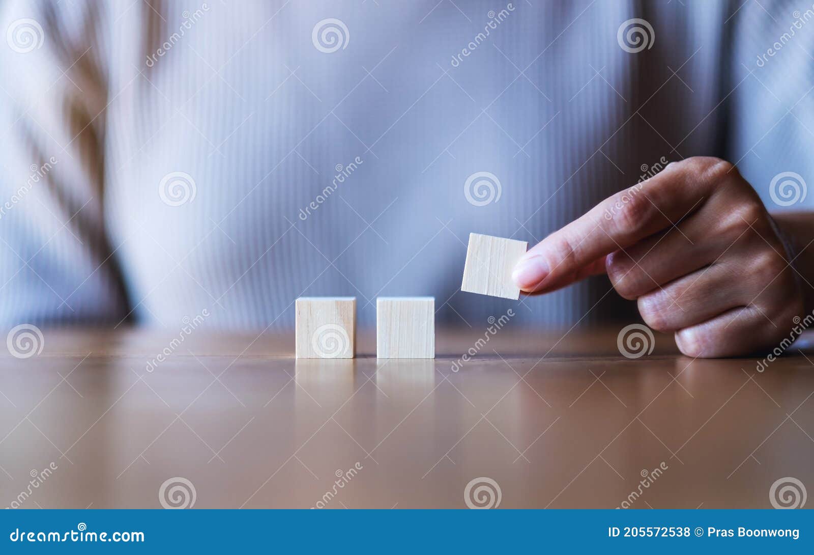 A Hand Choosing and Picking a Blank Wooden Cube Block Stock Photo ...