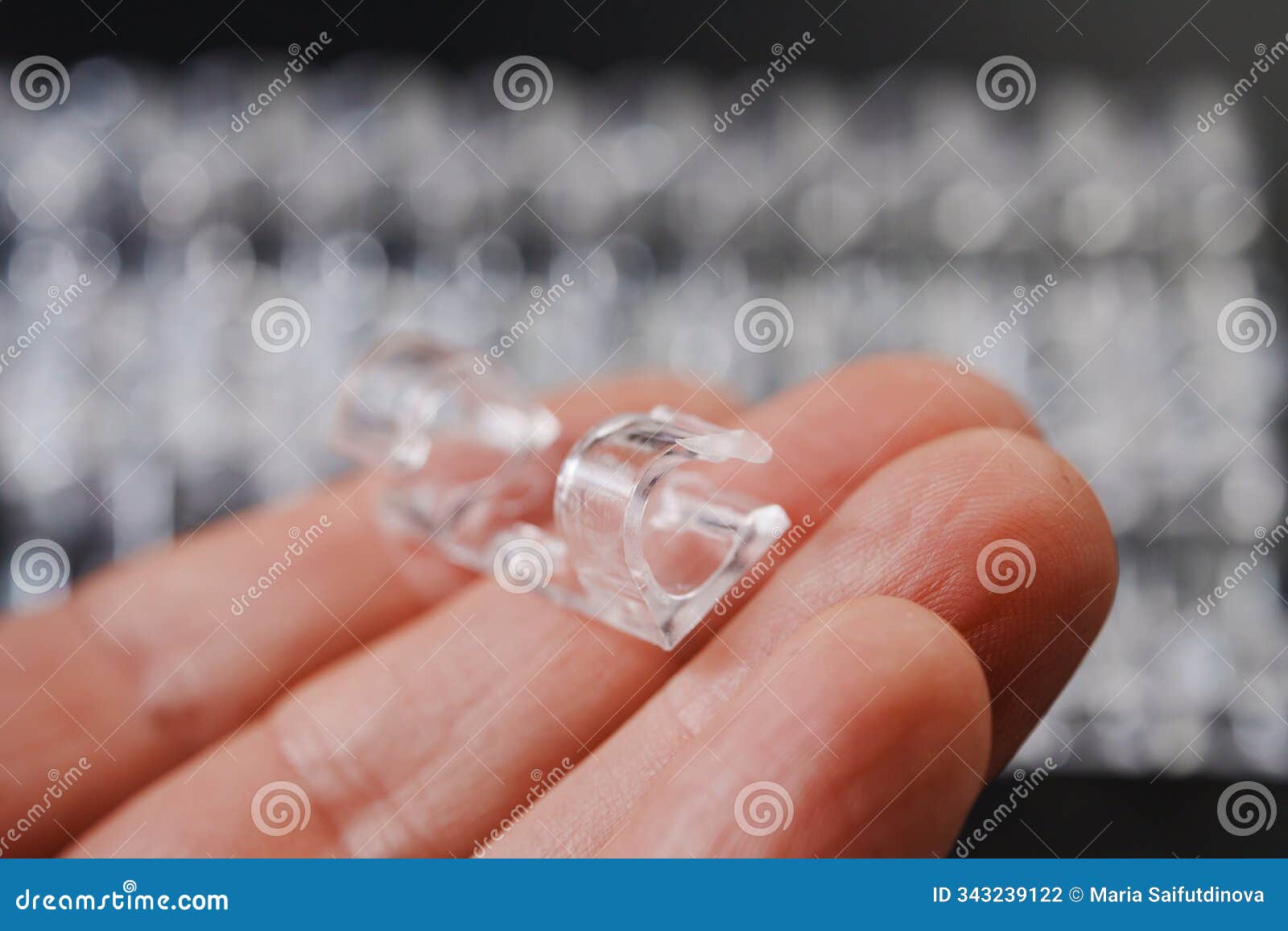 Hand and Clear Plastic Wire Holders on the Black Surface. Stock Photo ...