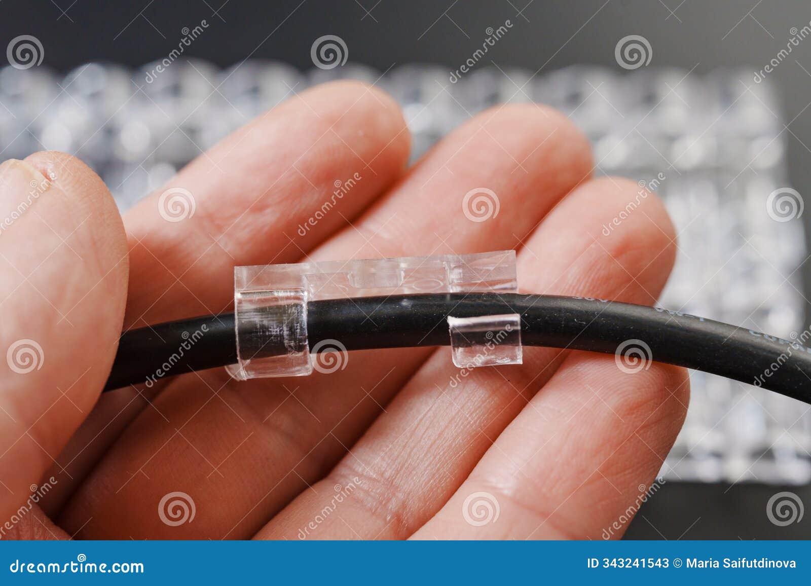 Hand and Clear Plastic Wire Holders on the Black Surface. Stock Image ...