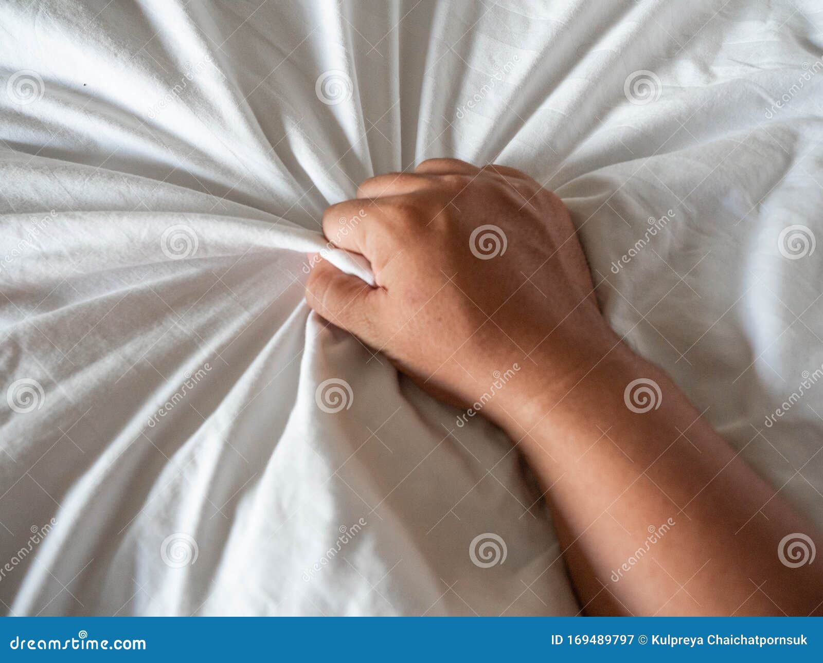 Hand Clenching Man on Bed White Color Stock Image - Image of white ...