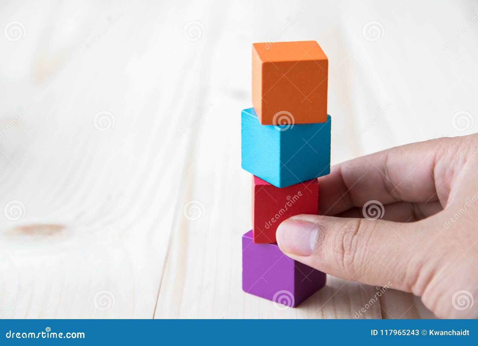 Hand on Colorful Stack of Wood Cube Building Blocks Stock Image - Image ... Hand on Colorful Stack of Wood Cube Building Blocks Stock Image - Image ...
