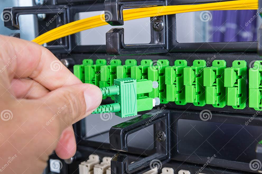 Hand of Computer Engineer Connecting Fiber Optic Cable in Server Stock ...