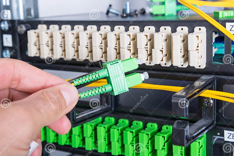 Hand of Computer Engineer Connecting Fiber Optic Cable in Server Stock ...