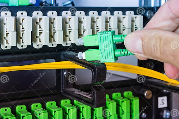 Hand of Computer Engineer Connecting Fiber Optic Cable in Server Stock ...