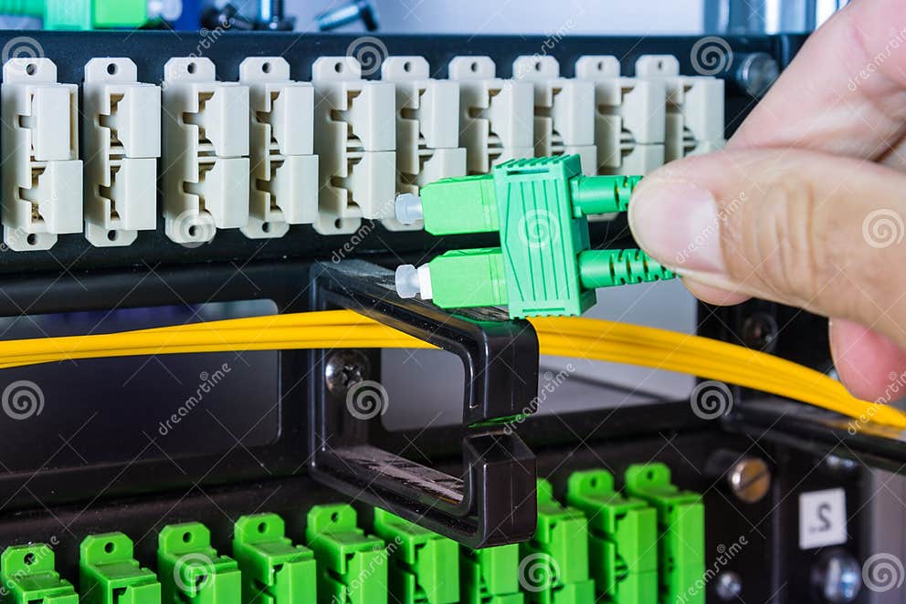 Hand of Computer Engineer Connecting Fiber Optic Cable in Server Stock ...
