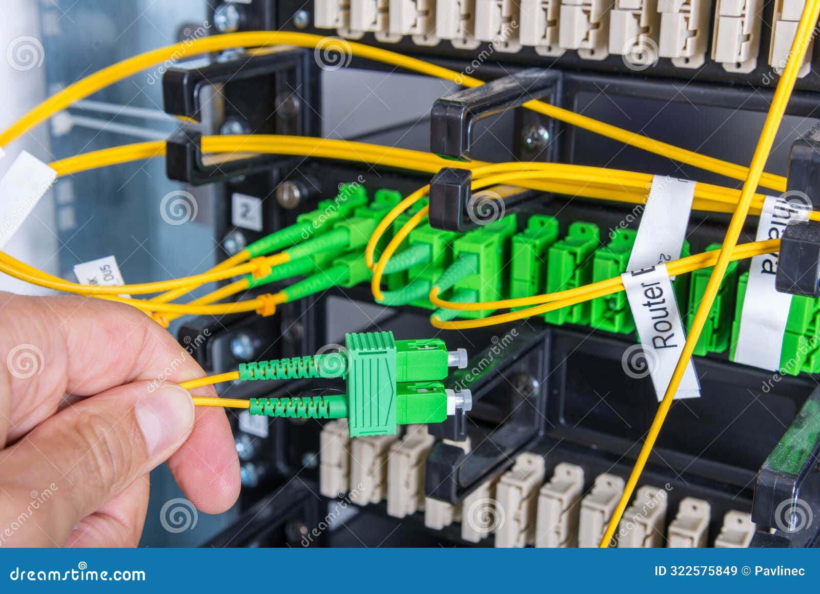 Hand of Computer Engineer Connecting Fiber Optic Cable in Server Stock ...