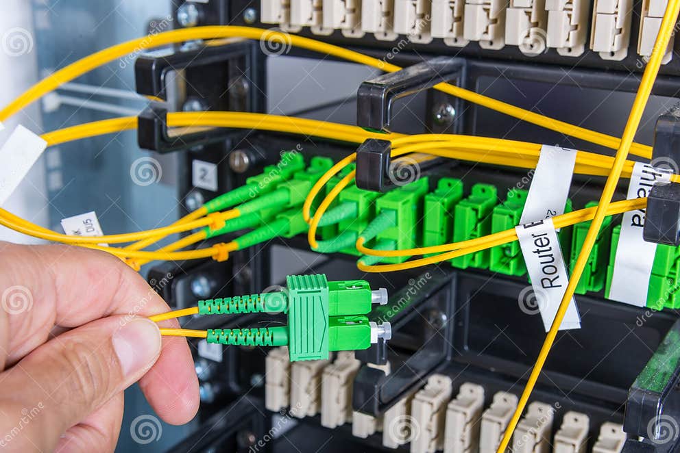 Hand of Computer Engineer Connecting Fiber Optic Cable in Server Stock ...