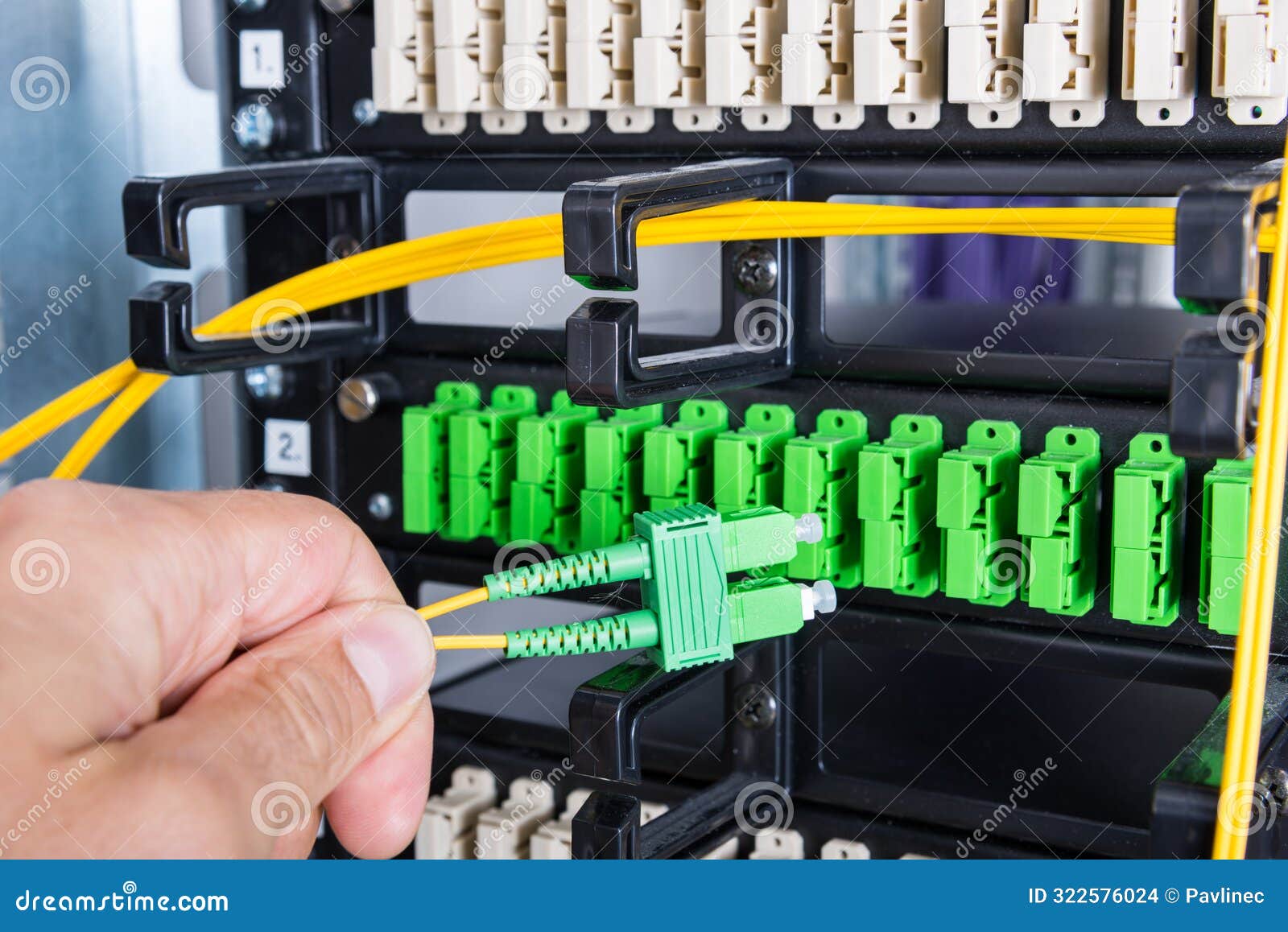 Hand of Computer Engineer Connecting Fiber Optic Cable in Server Stock ...