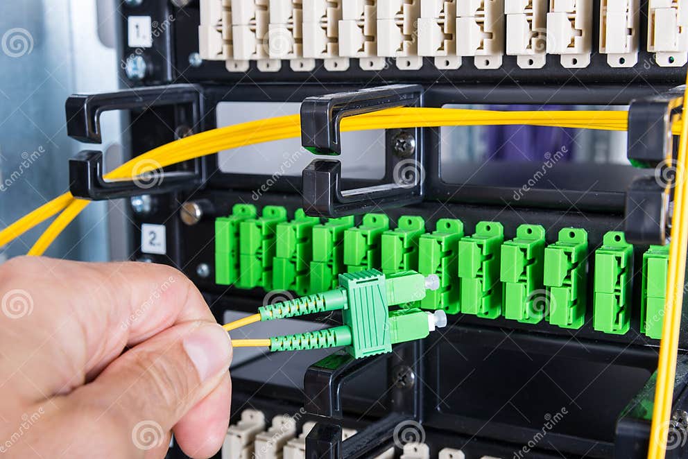 Hand of Computer Engineer Connecting Fiber Optic Cable in Server Stock ...