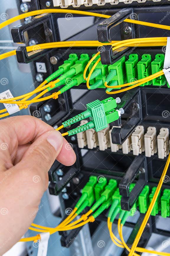 Hand of Computer Engineer Connecting Fiber Optic Cable in Server Stock ...