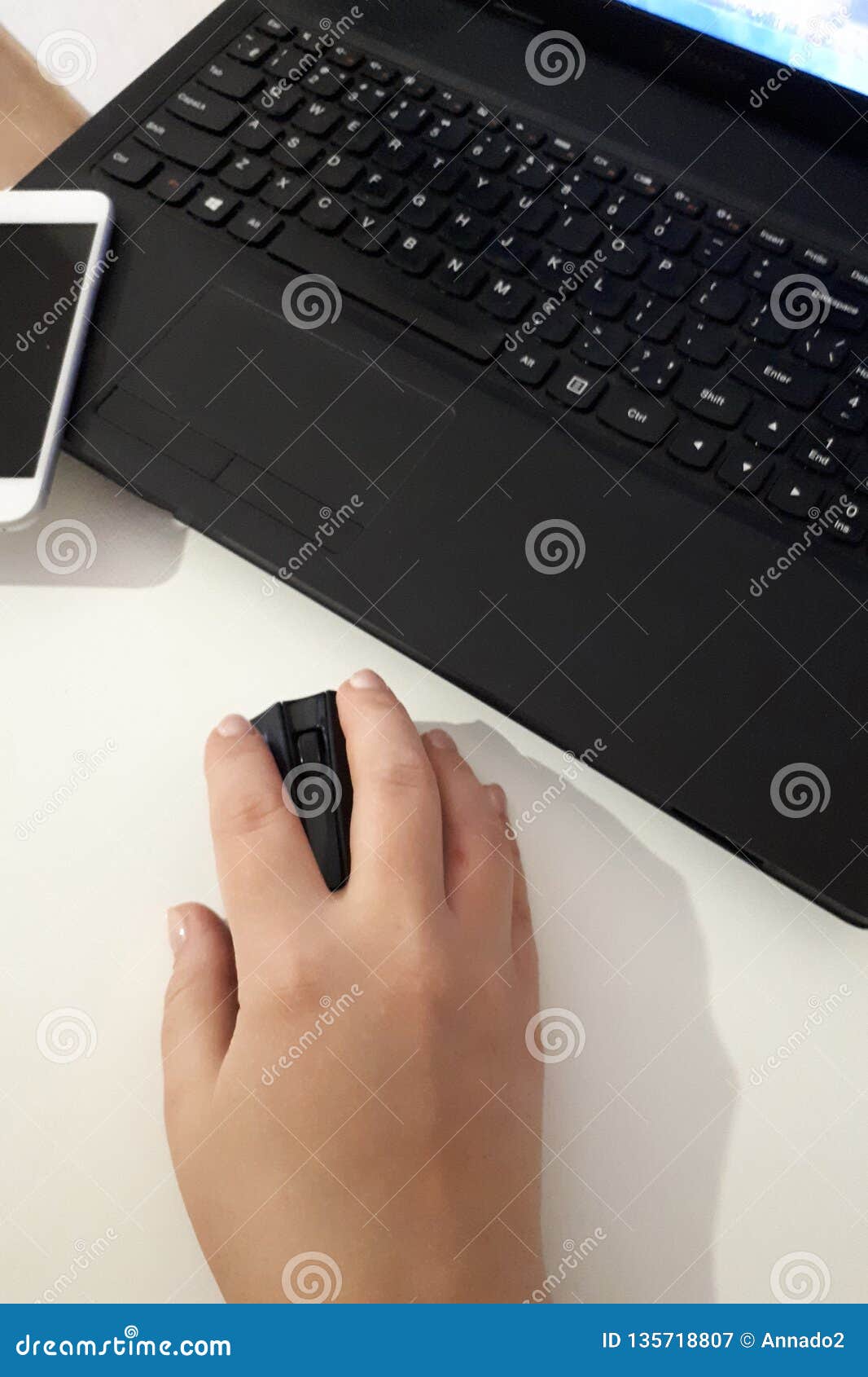 Hand with Computer Mouse beside Laptop Keyboard on a White Background ...