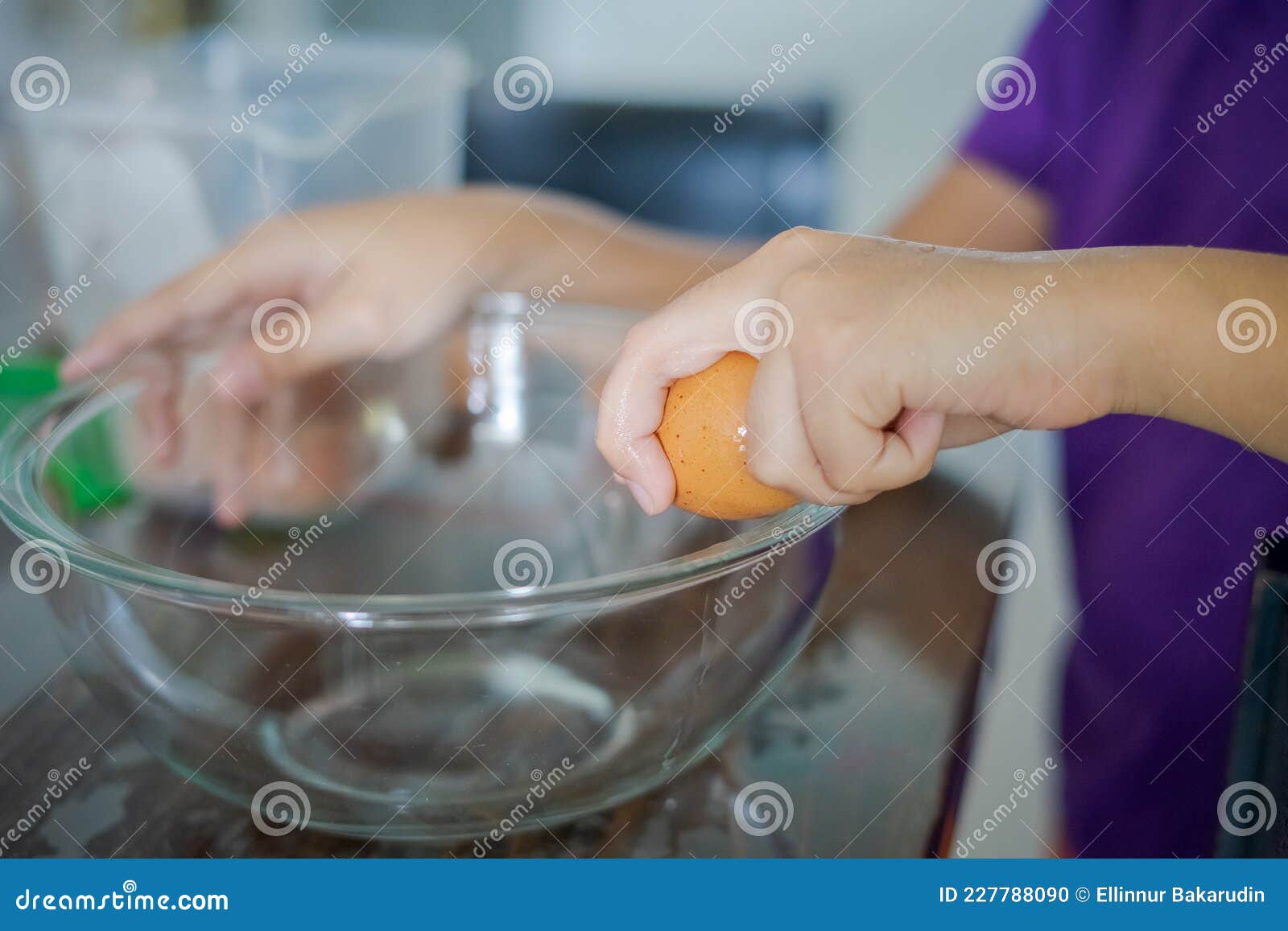 Hand Cracking an Egg into a Bowl. Cooking at Home Stock Photo - Image ...