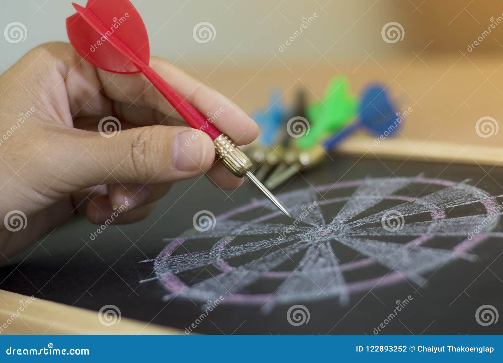 Hand with a Dart is Aiming at a Dartboard Stock Photo - Image of coins ... Hand with a Dart is Aiming at a Dartboard Stock Photo - Image of coins ...