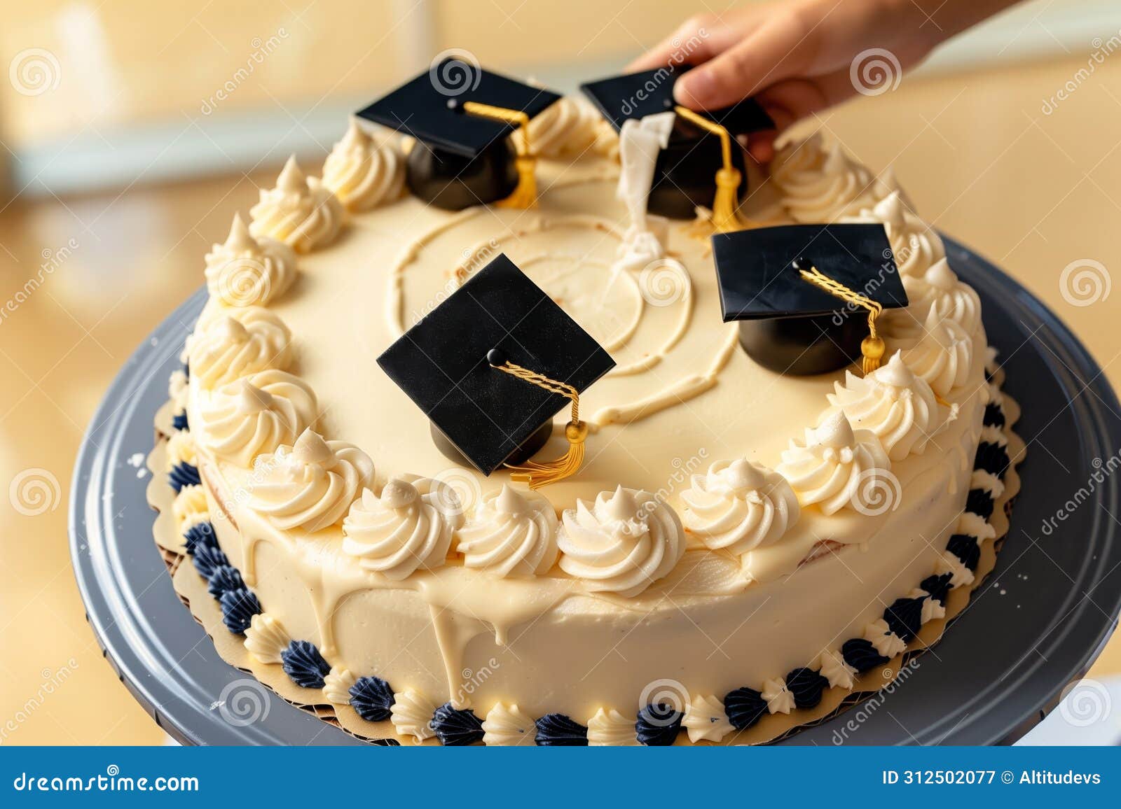 Hand Decorating a Cake with Graduation Cap Toppers Stock Image - Image ...