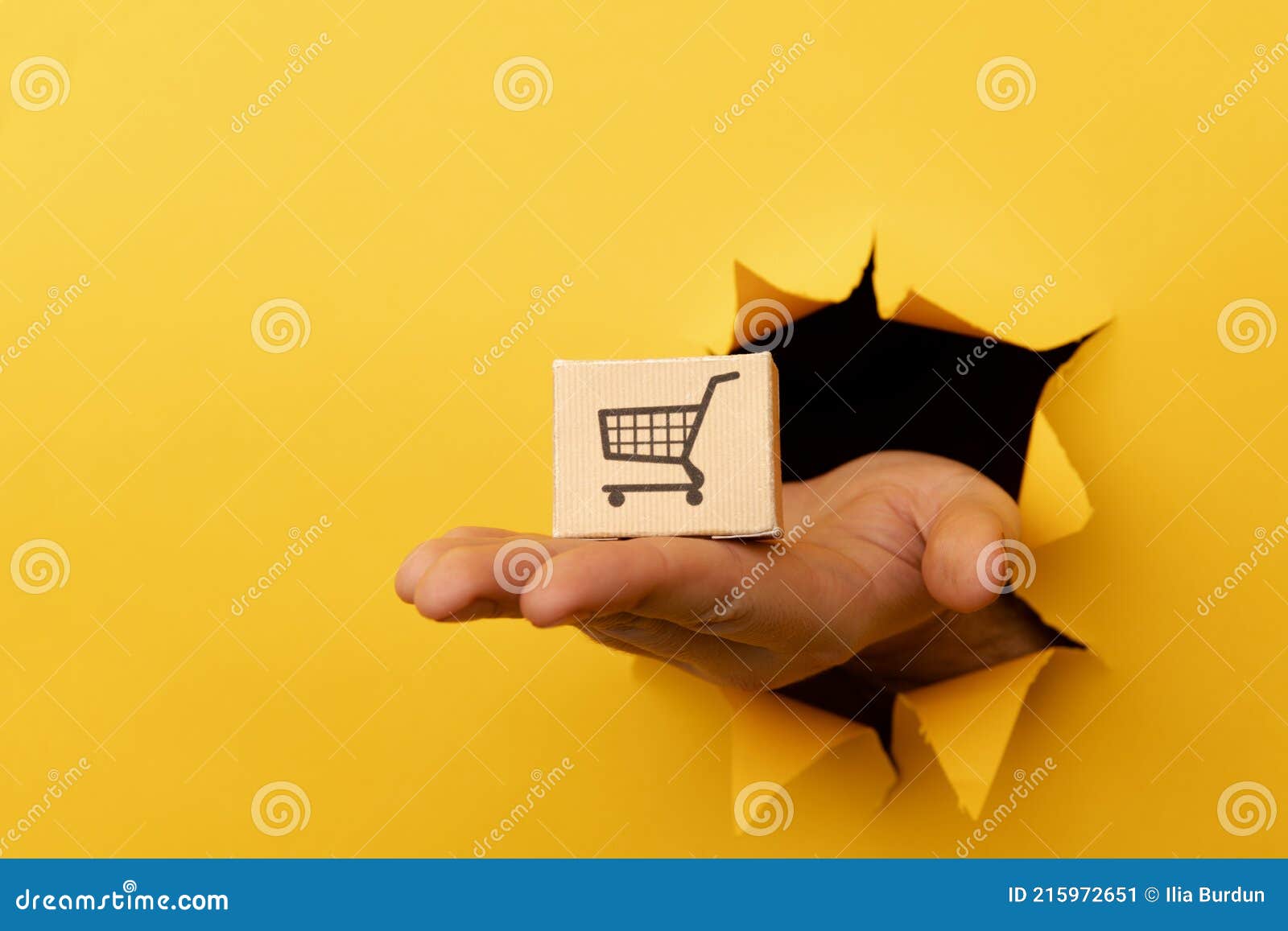 Hand with a Delivery Box through a Yellow Paper Hole. Delivery Concept ...