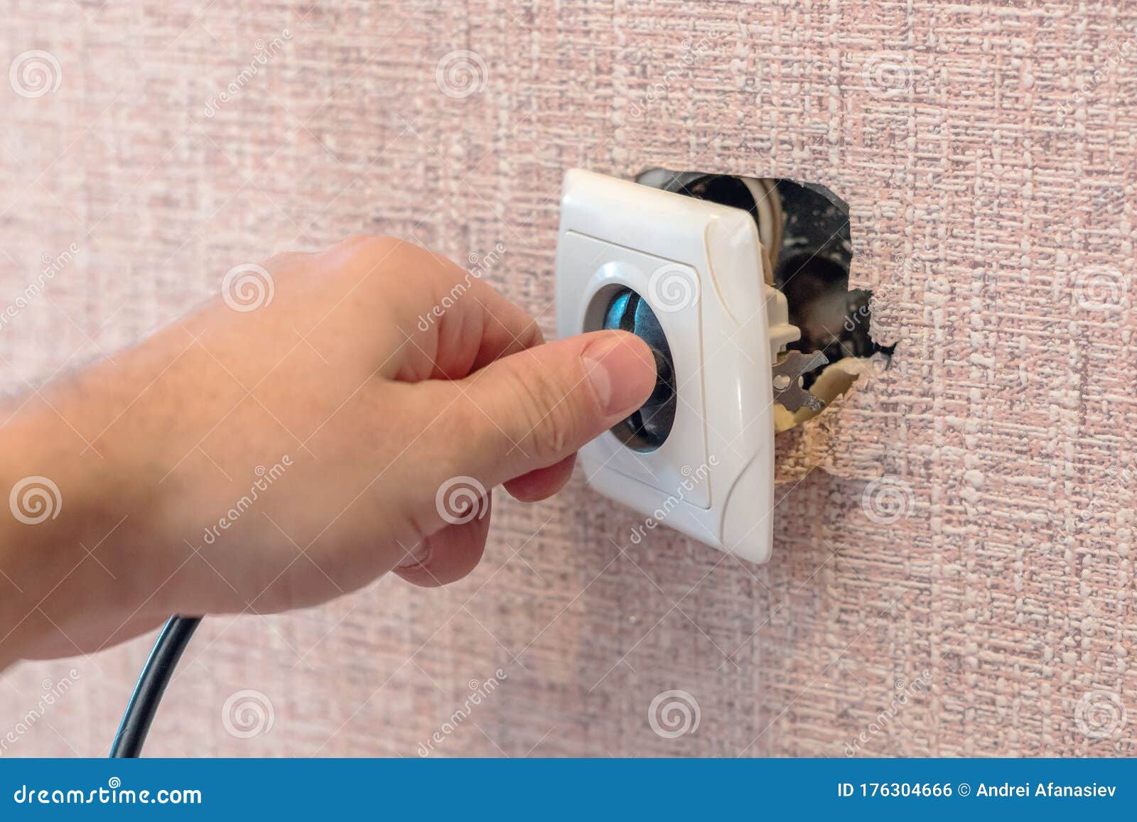 Hand Disconnects Or Connects The Plug To A Broken Outlet, Risk Of ...