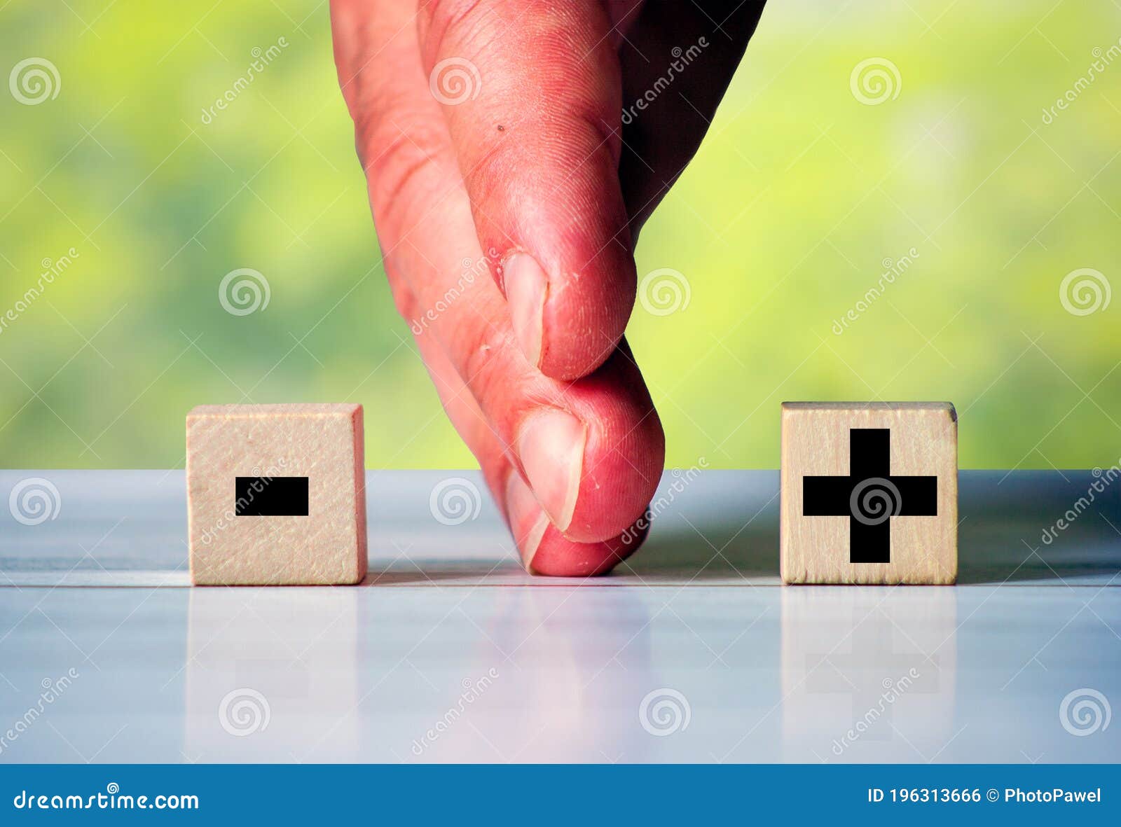 Hand Divides Two Wooden Blocks with the Words Plus and Minus Stock ...