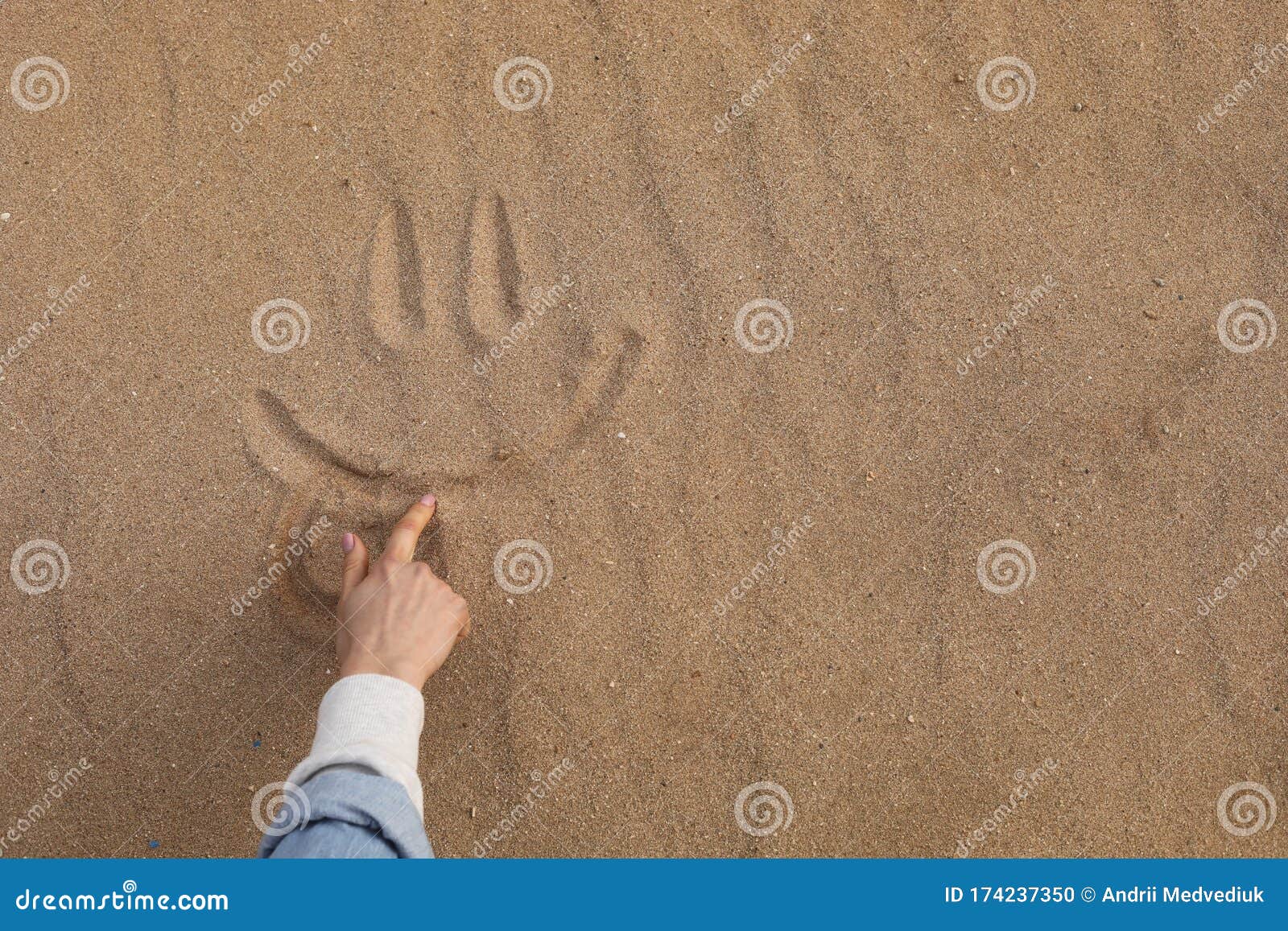 Hand Drawing a Beautiful Cute Smile in Desert Sand - Background Stock ...