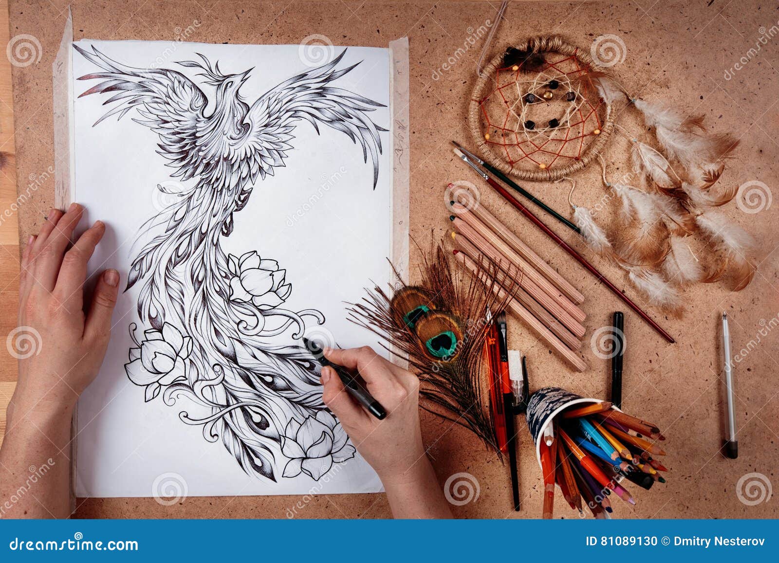 Hand Drawing a Phoenix in Creative Environment. Stock Photo - Image of ...