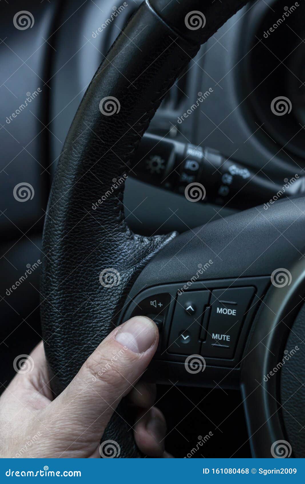 Hand of Driver on Steering Wheel Adjusts Audio Volume Control Stock ...