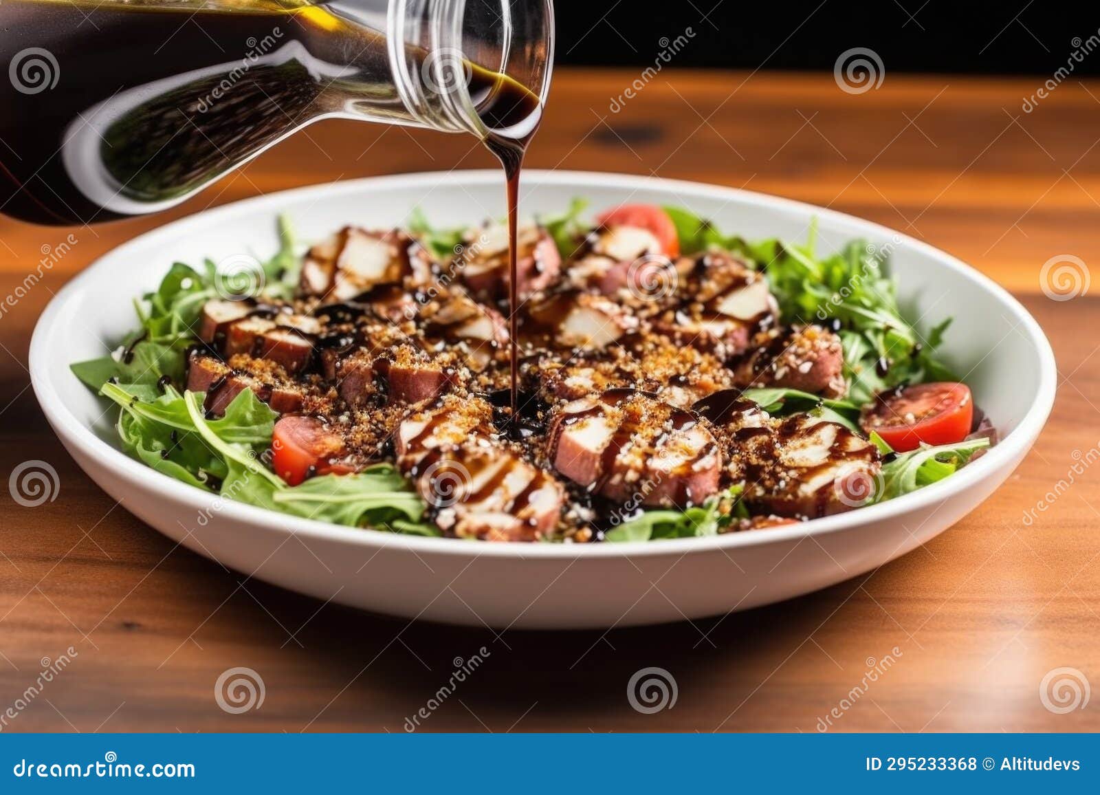Hand Drizzling Balsamic Glaze Over Quinoa and Arugula Salad Stock Photo ...