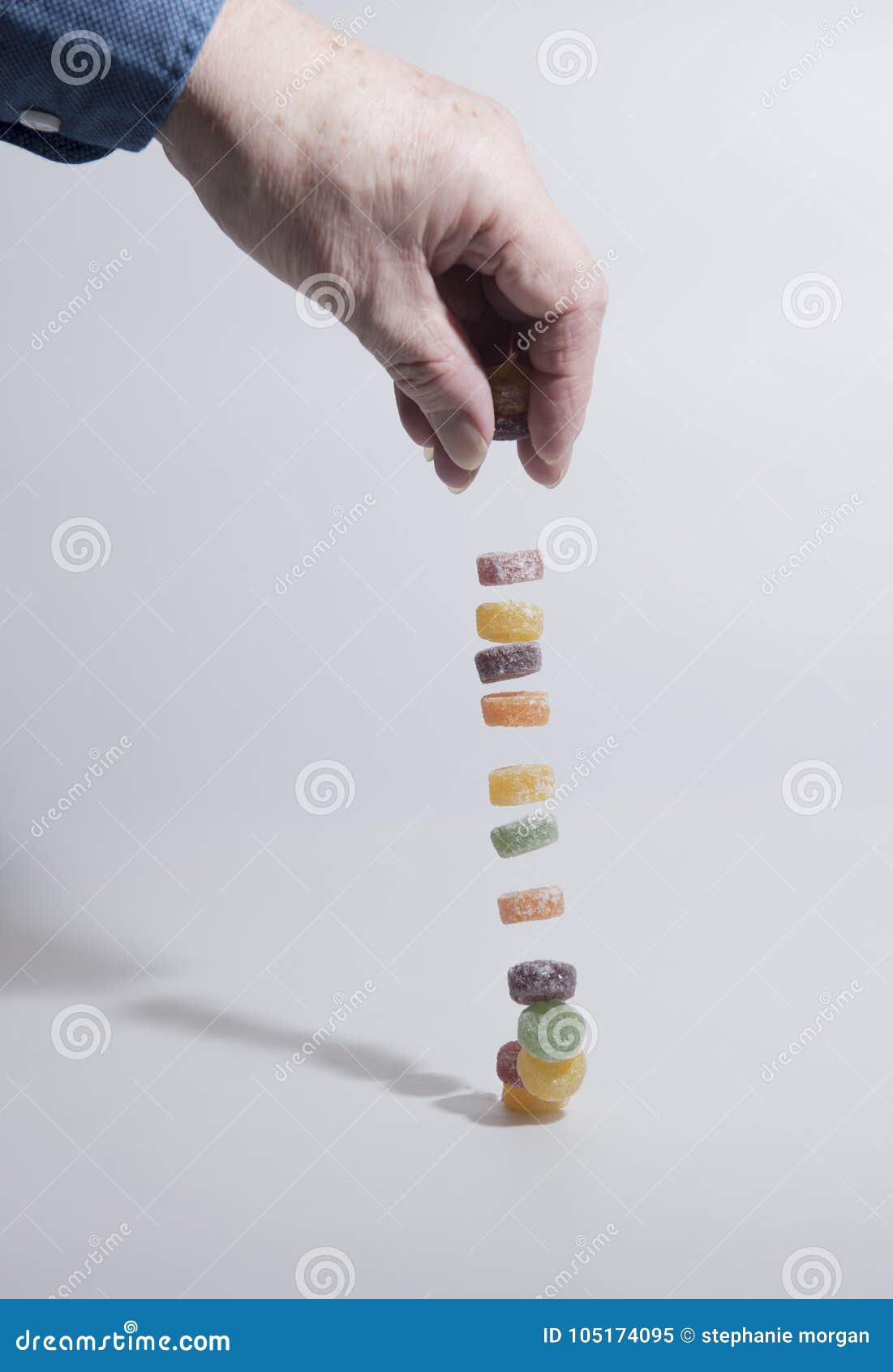 Hand Dropping Lots of Multi Coloured Candy Stock Image - Image of ...