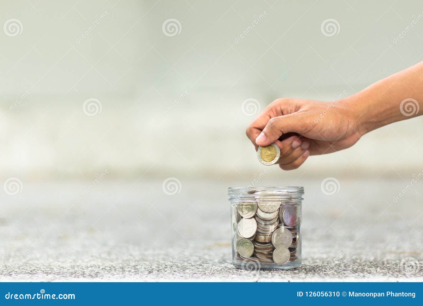 Hand Drops Money into a Glass Jar for a Savings Stock Photo - Image of ...