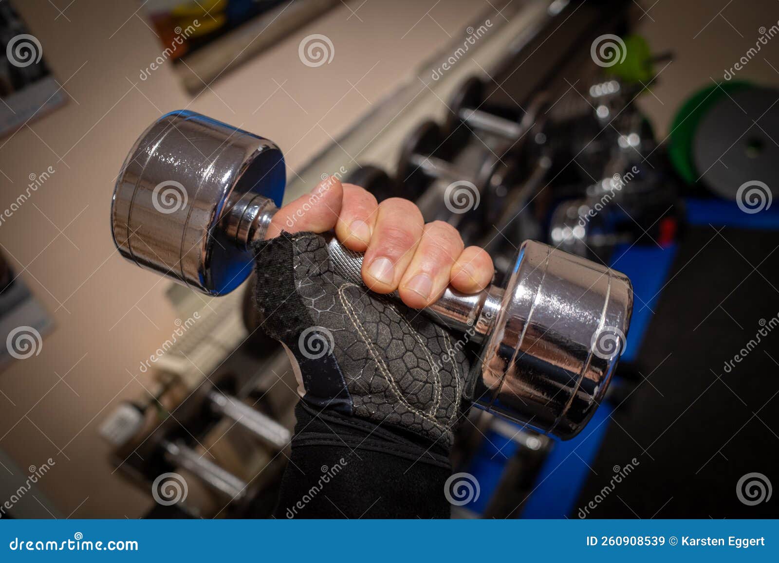 In one hand is a dumbbell stock image. Image of dumbbell - 260908539