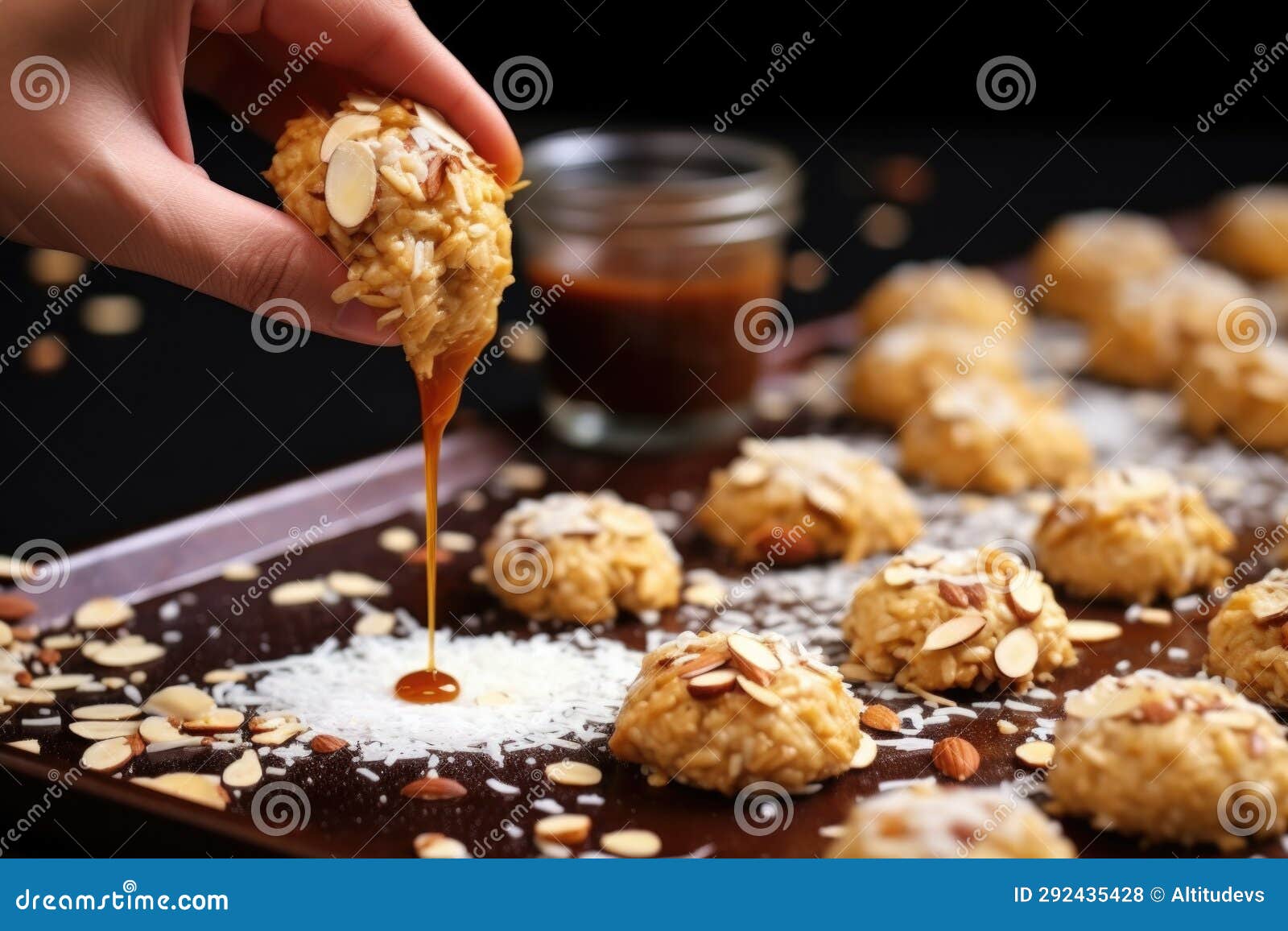 Hand Dusting Crushed Nuts Over Caramel-drizzled Cookies Stock Photo ...