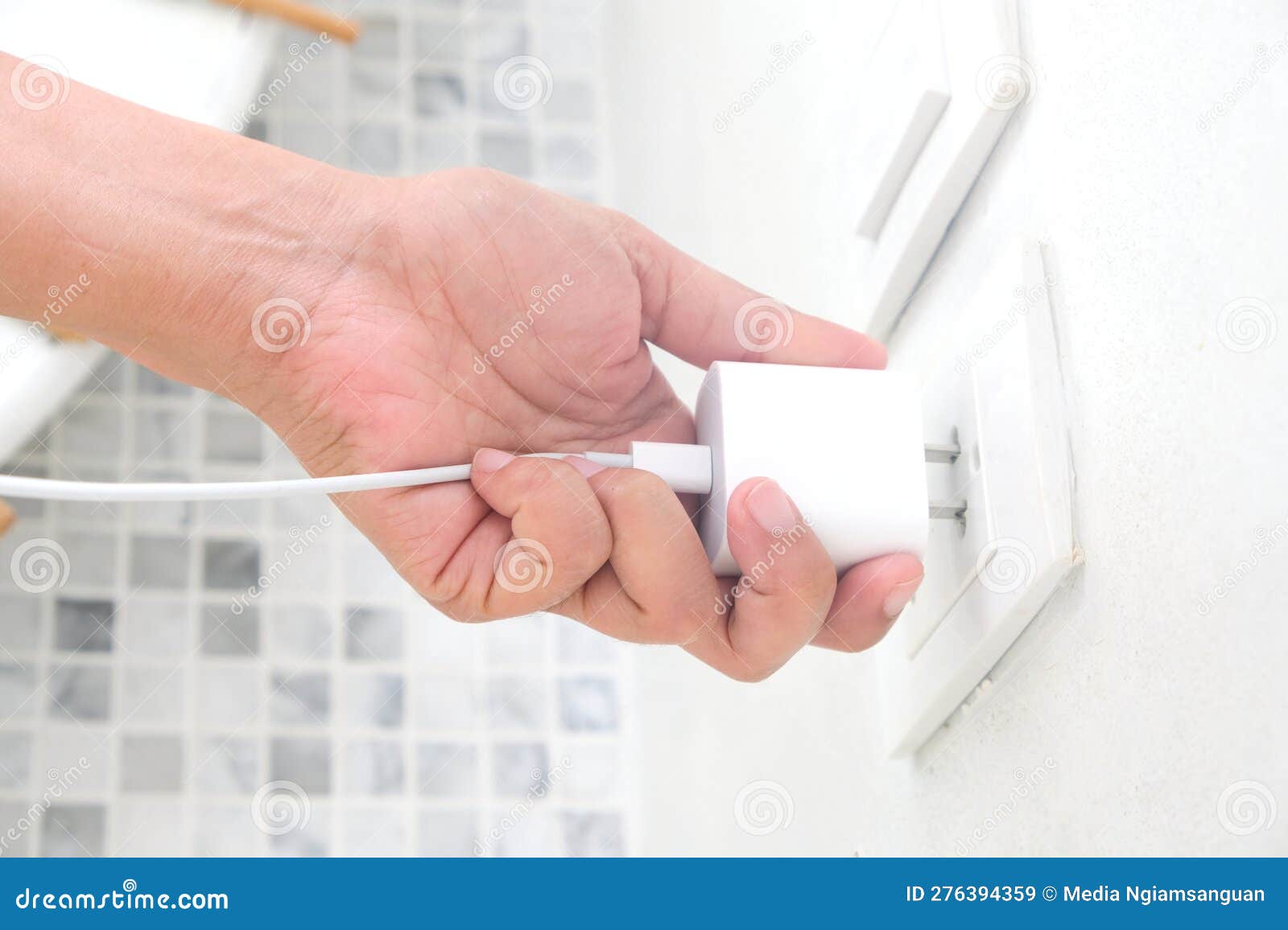 Pulling An Electrical Cable Out Of A Wall Socket To Save Energy Royalty ...