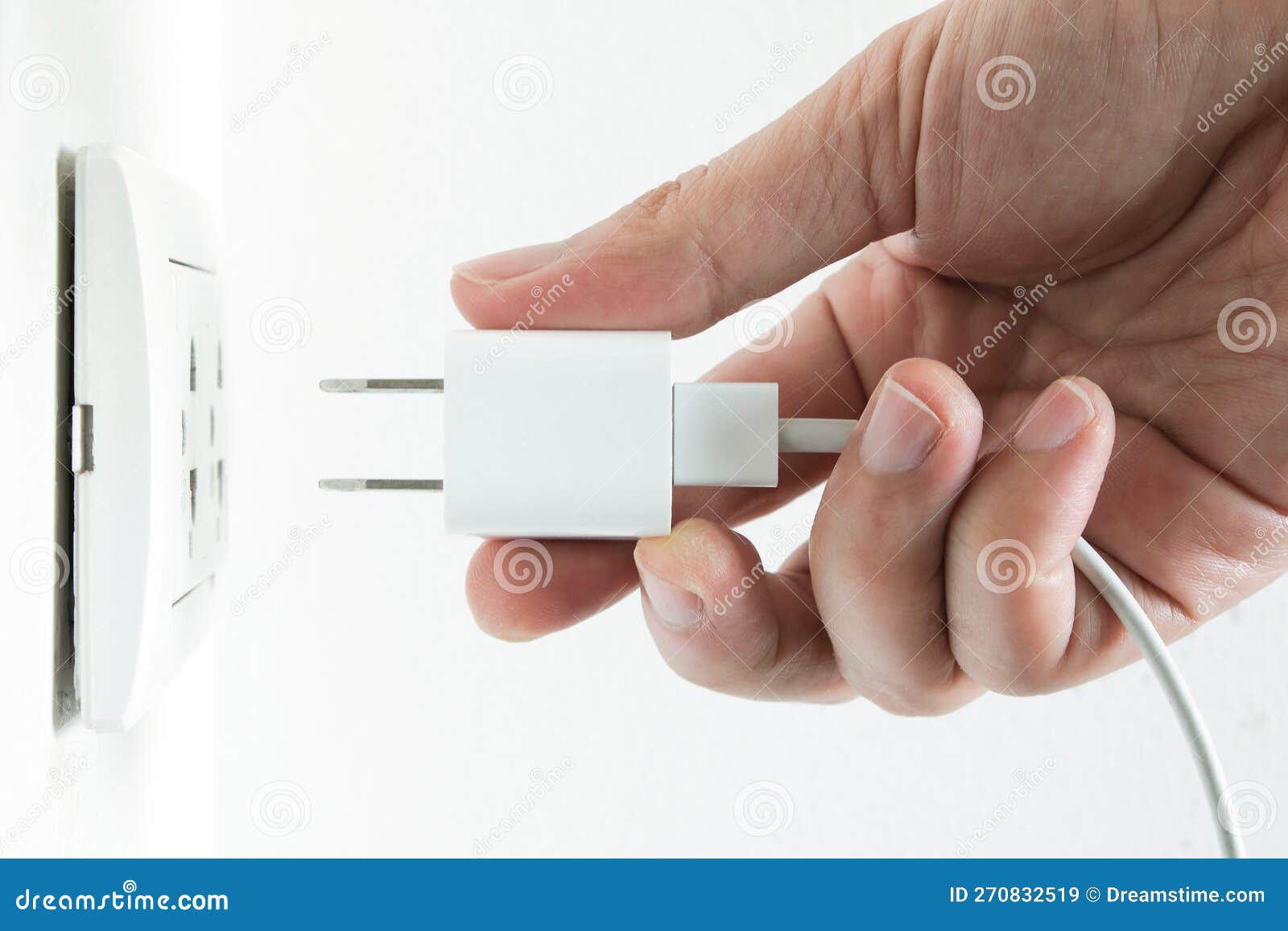 Pulling An Electrical Cable Out Of A Wall Socket To Save Energy Royalty ...