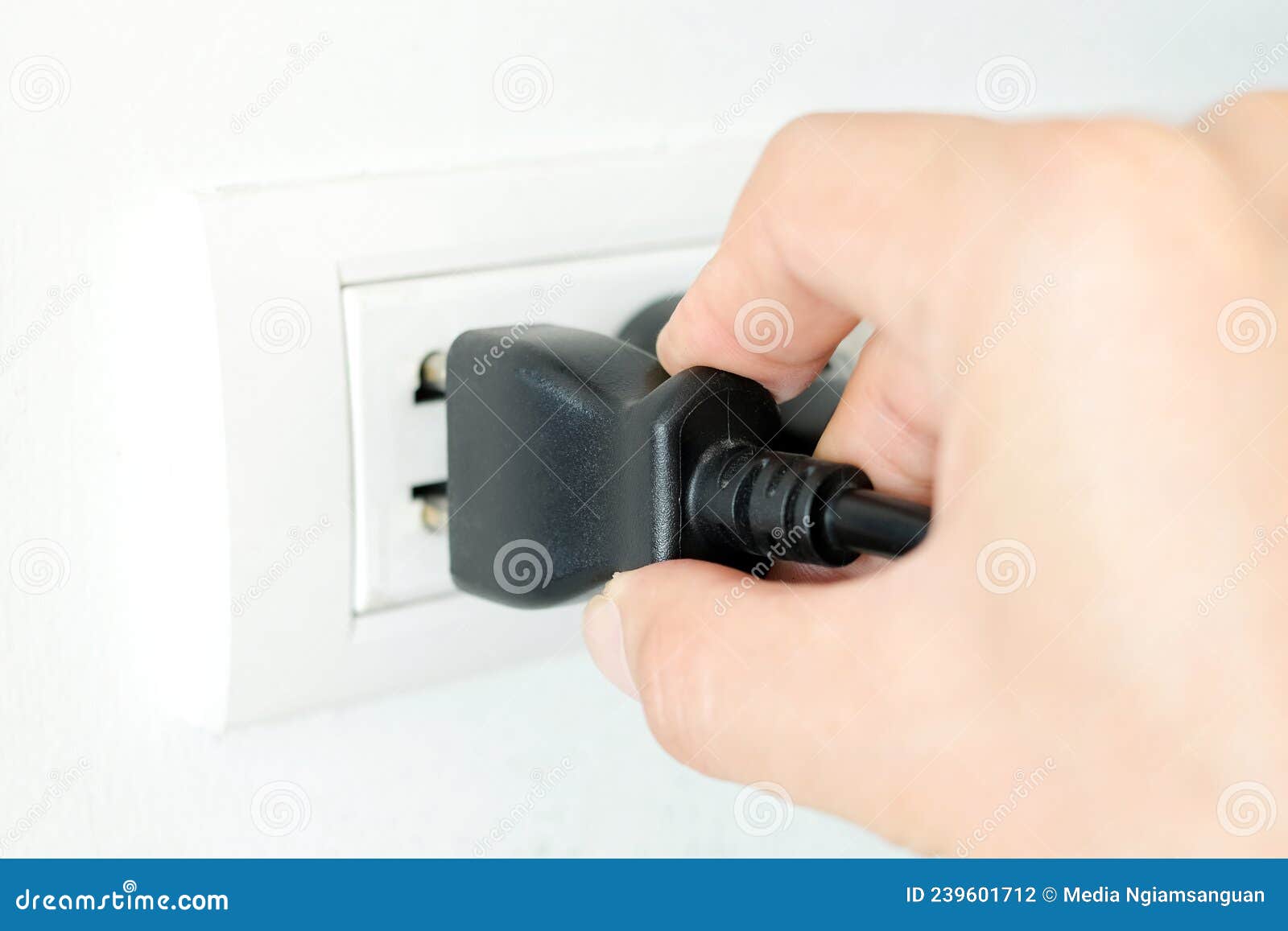 Pulling An Electrical Cable Out Of A Wall Socket To Save Energy Royalty ...