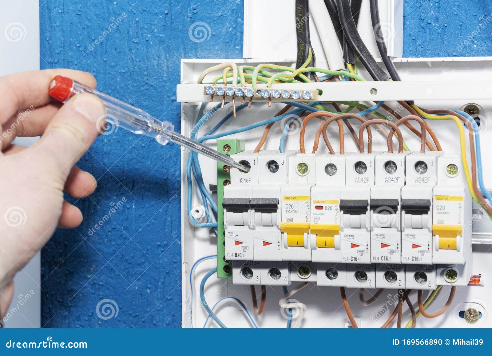 Hand of an Electrician with Multimeter Probe at an Electrical ...