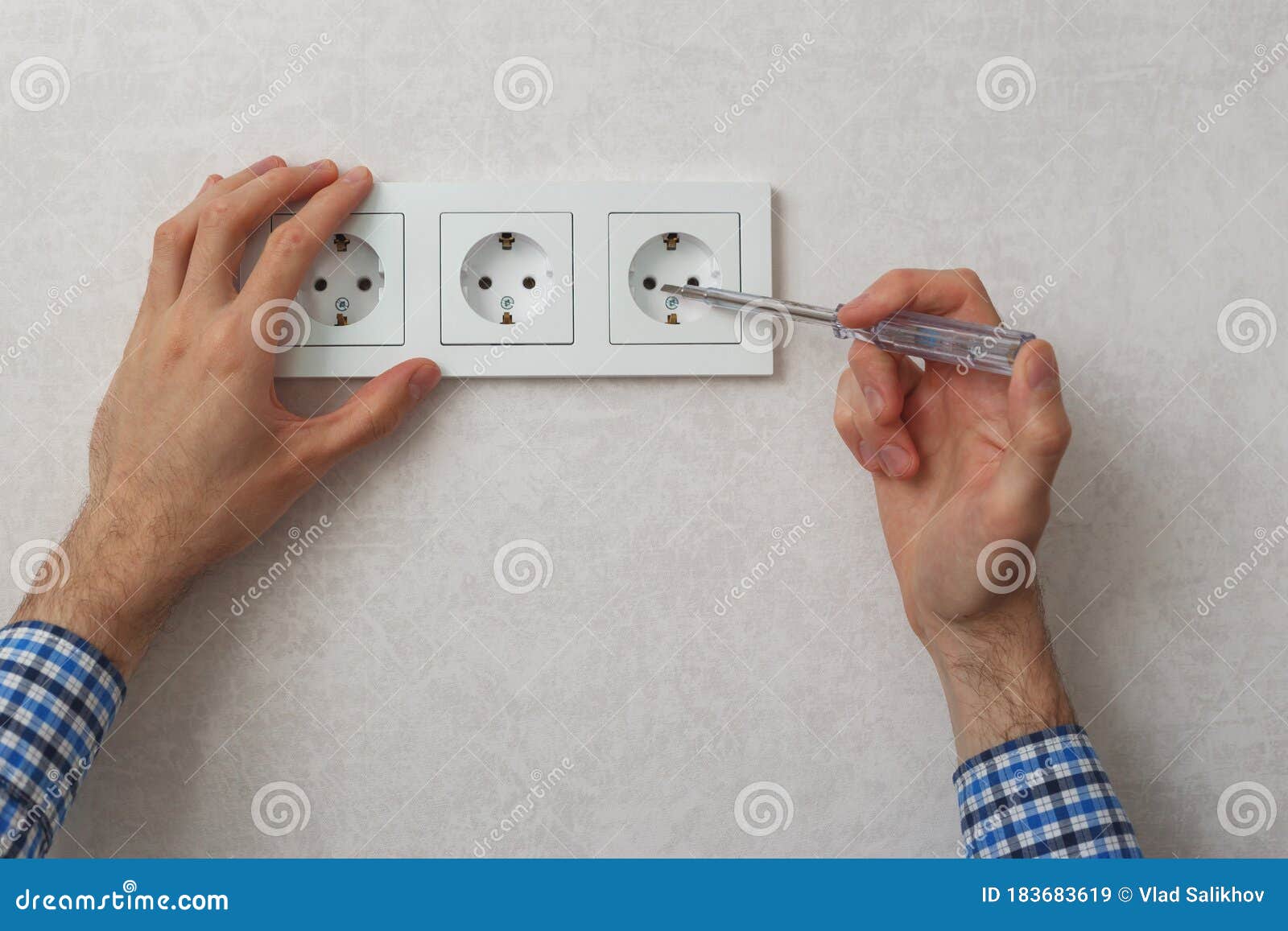 Hand of Electrician Using Phase Tester Screwdriver To Repair Wall ...