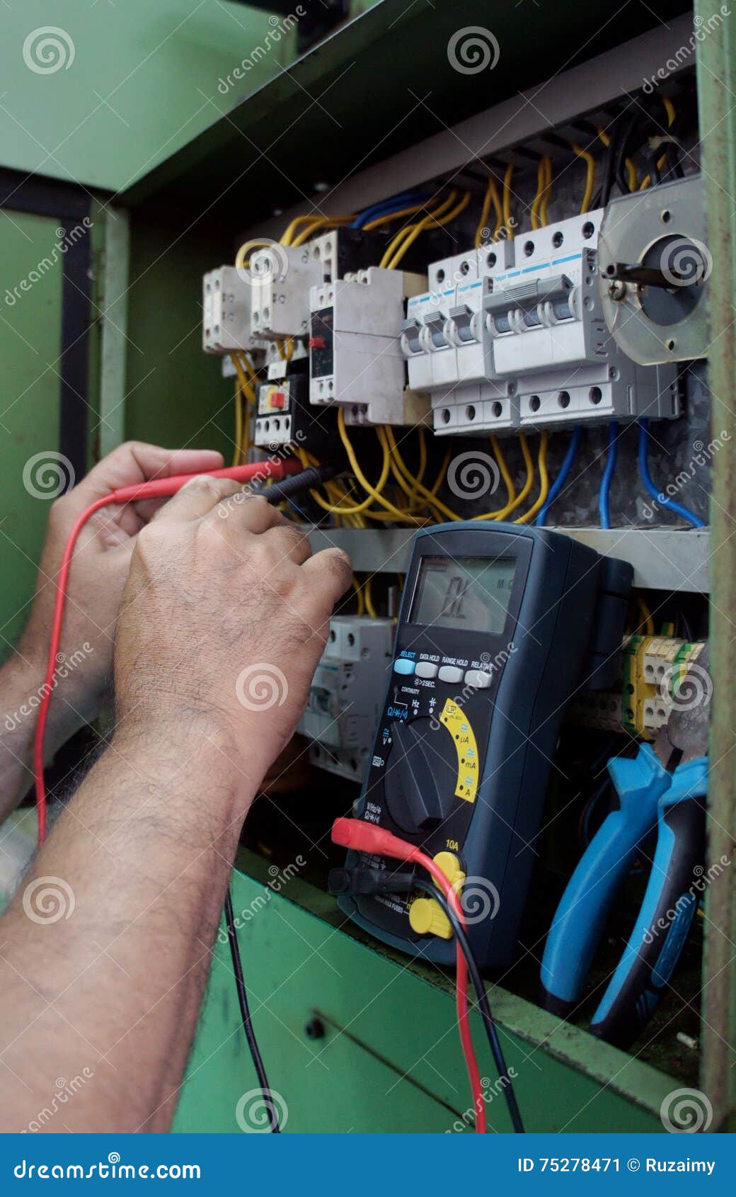 A Hand of Electrician Worker Testing Industrial Machine Stock Image ...