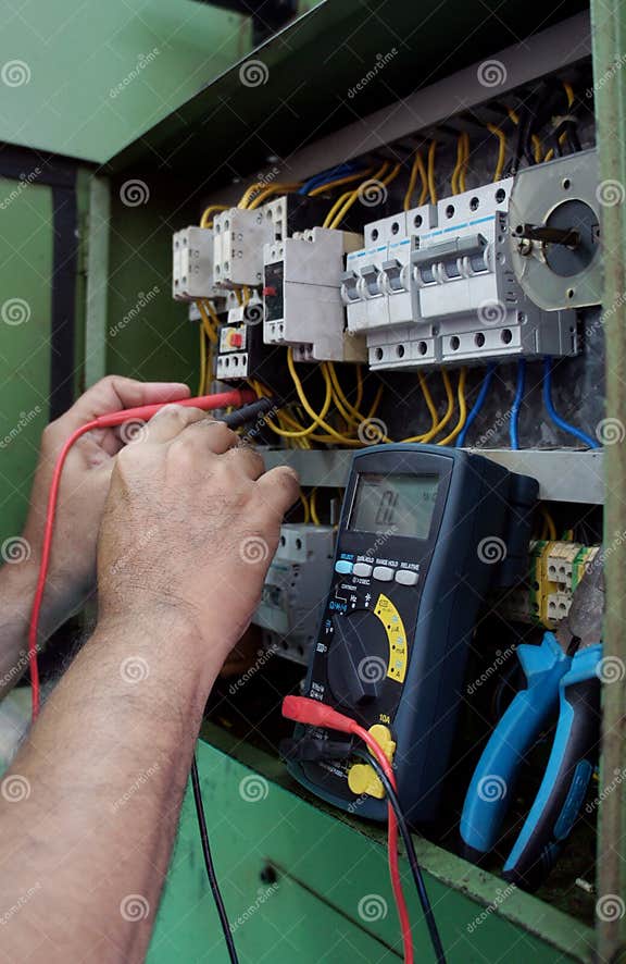 A Hand of Electrician Worker Testing Industrial Machine Stock Image ...