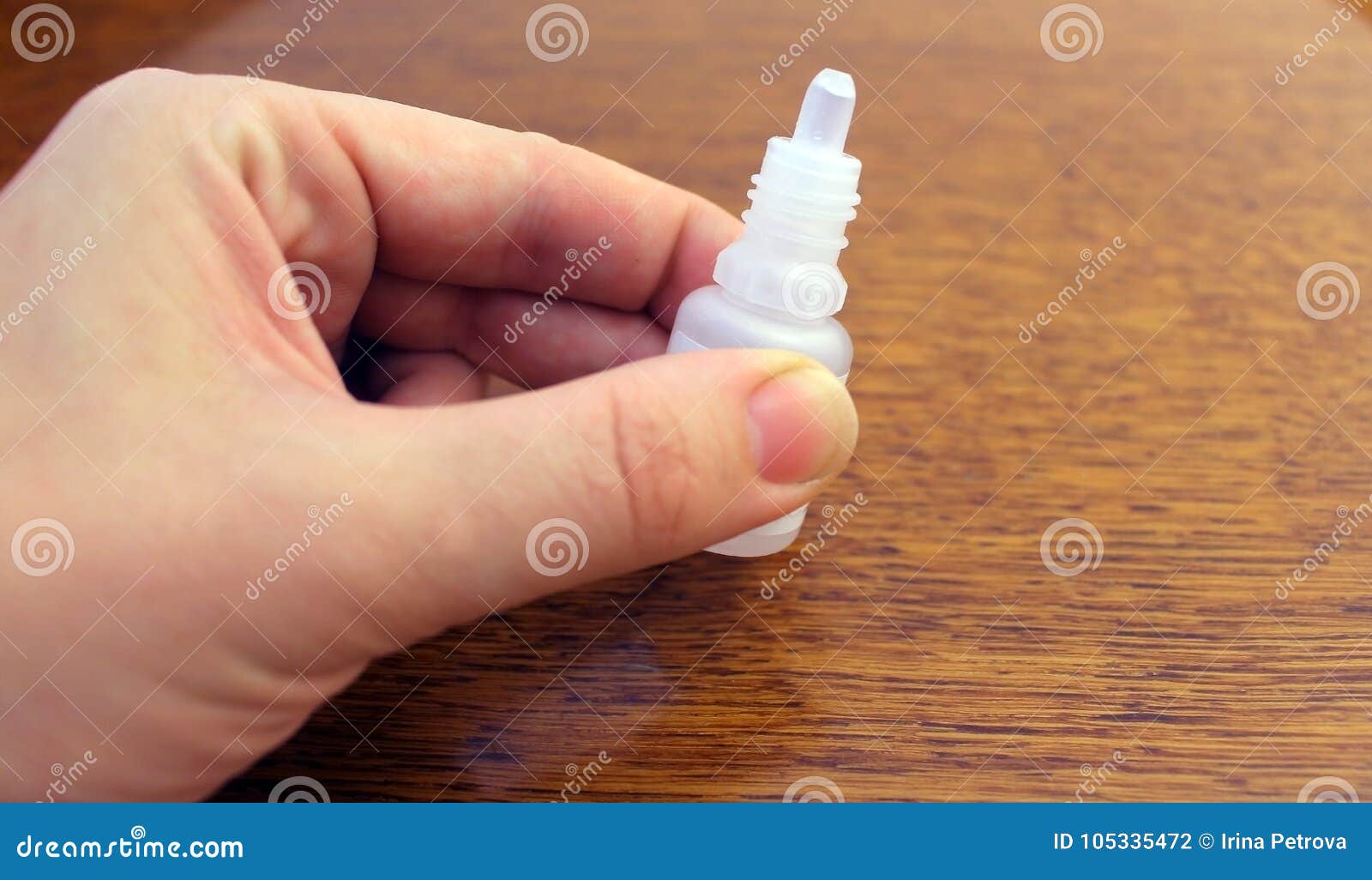 Hand with eye drop bottle stock photo. Image of macro - 105335472