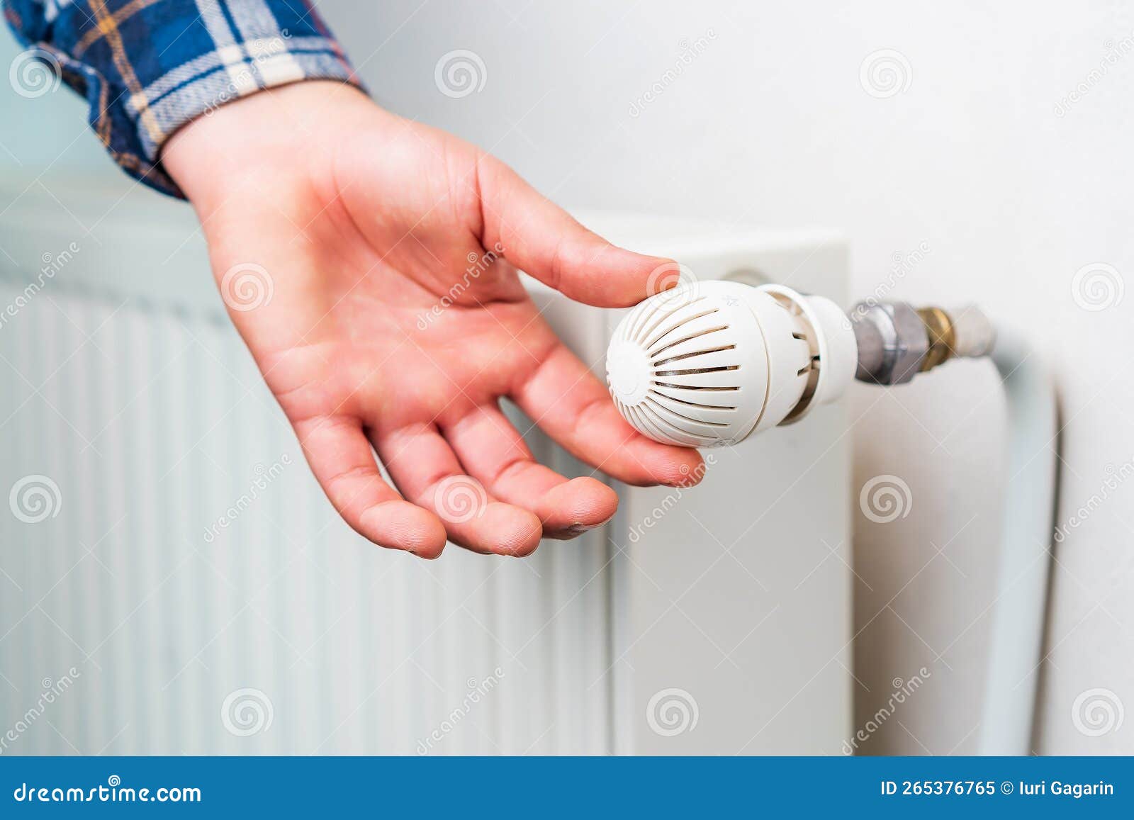 Hand on the Faucet or Temperature Regulator on the Radiator of the ...