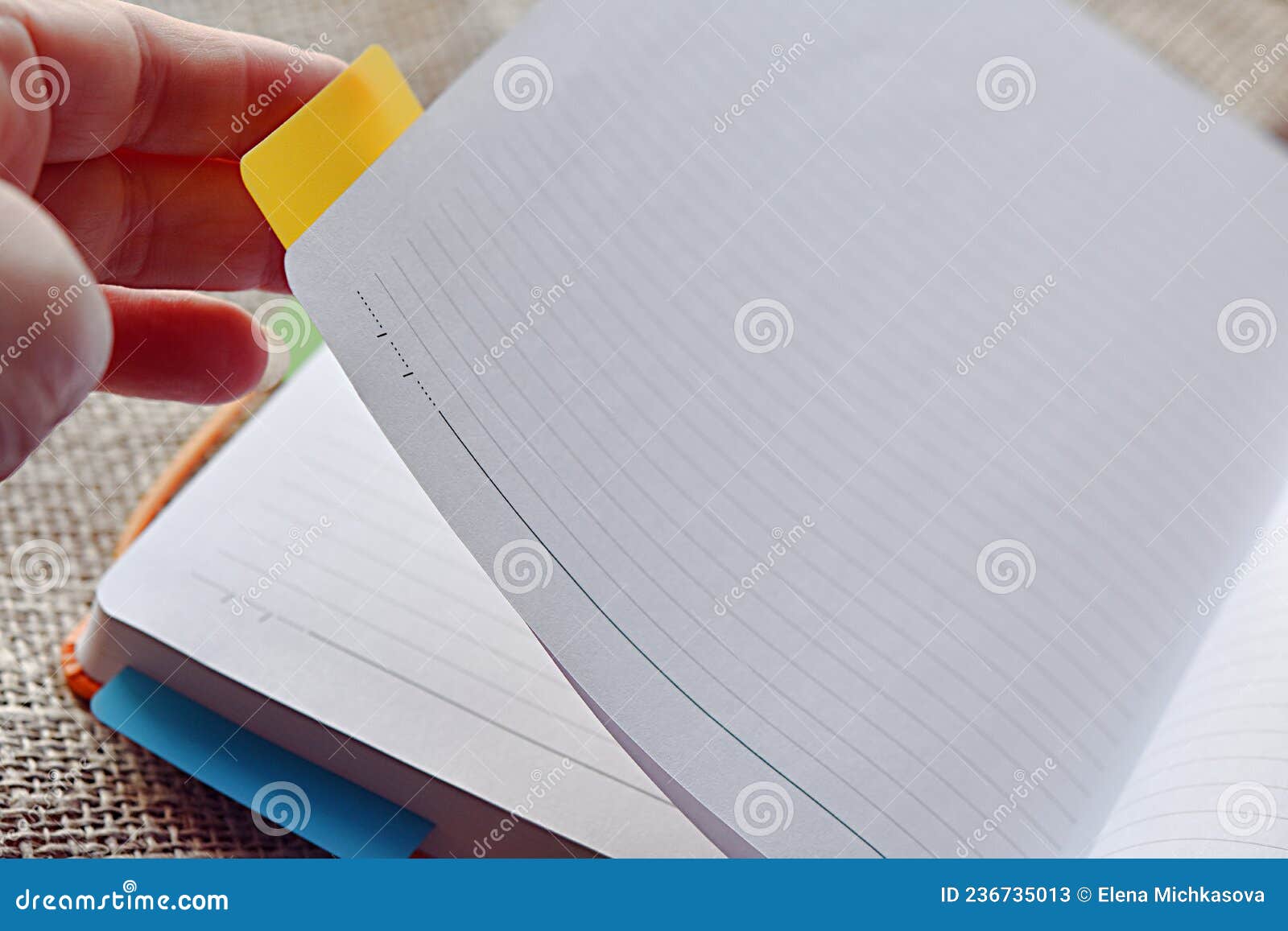 Hand Flips through a Notebook with Many Colorful Bookmarks Stock Image ...