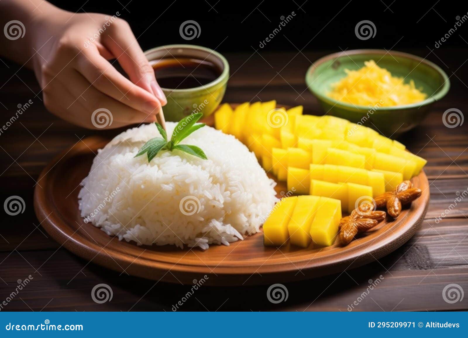 Hand Garnishing a Plate of Mango Sticky Rice with a Star Anise Stock ...