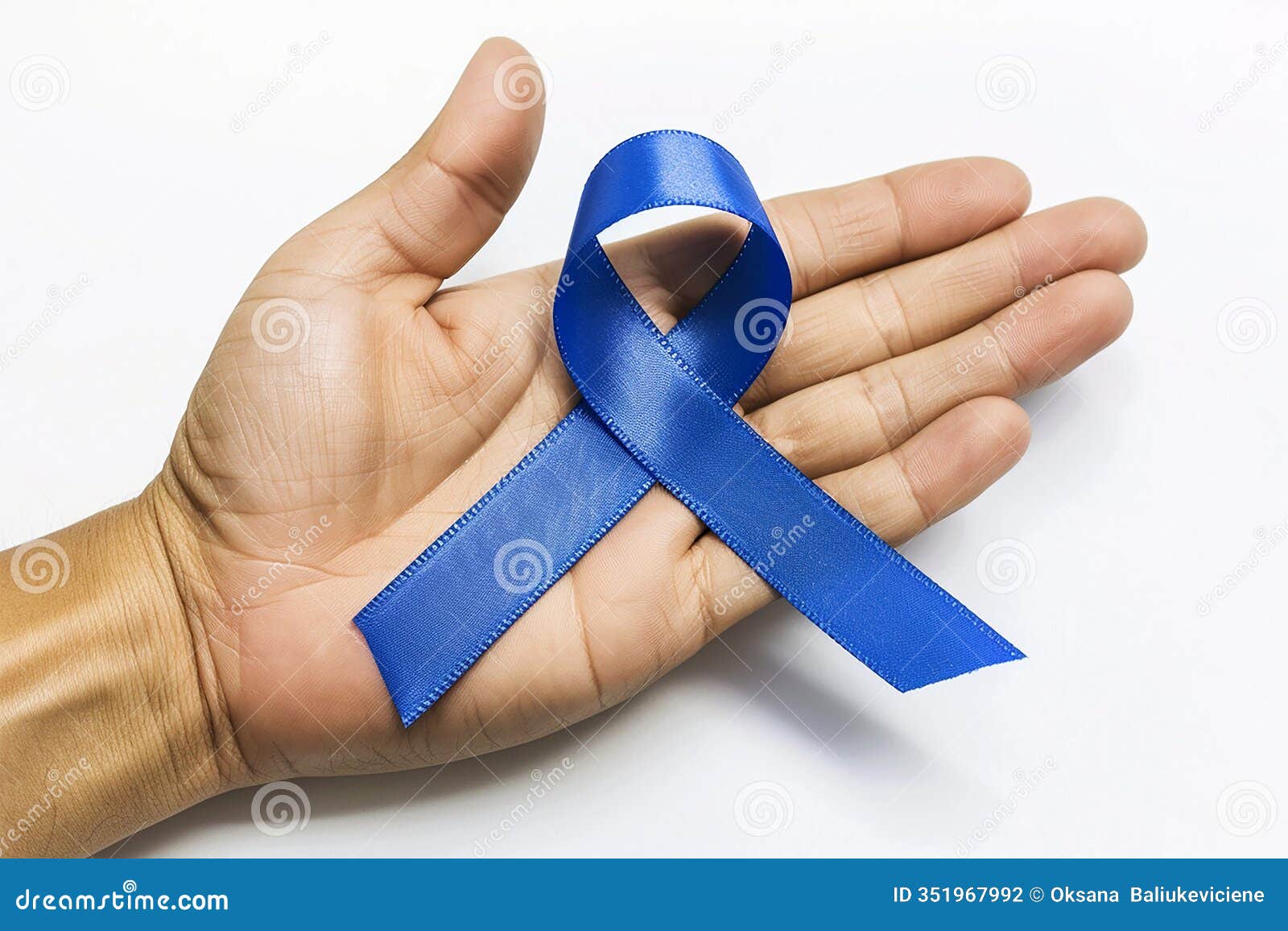 A Hand Gently Holds a Blue Awareness Ribbon Symbolizing Hope and ...
