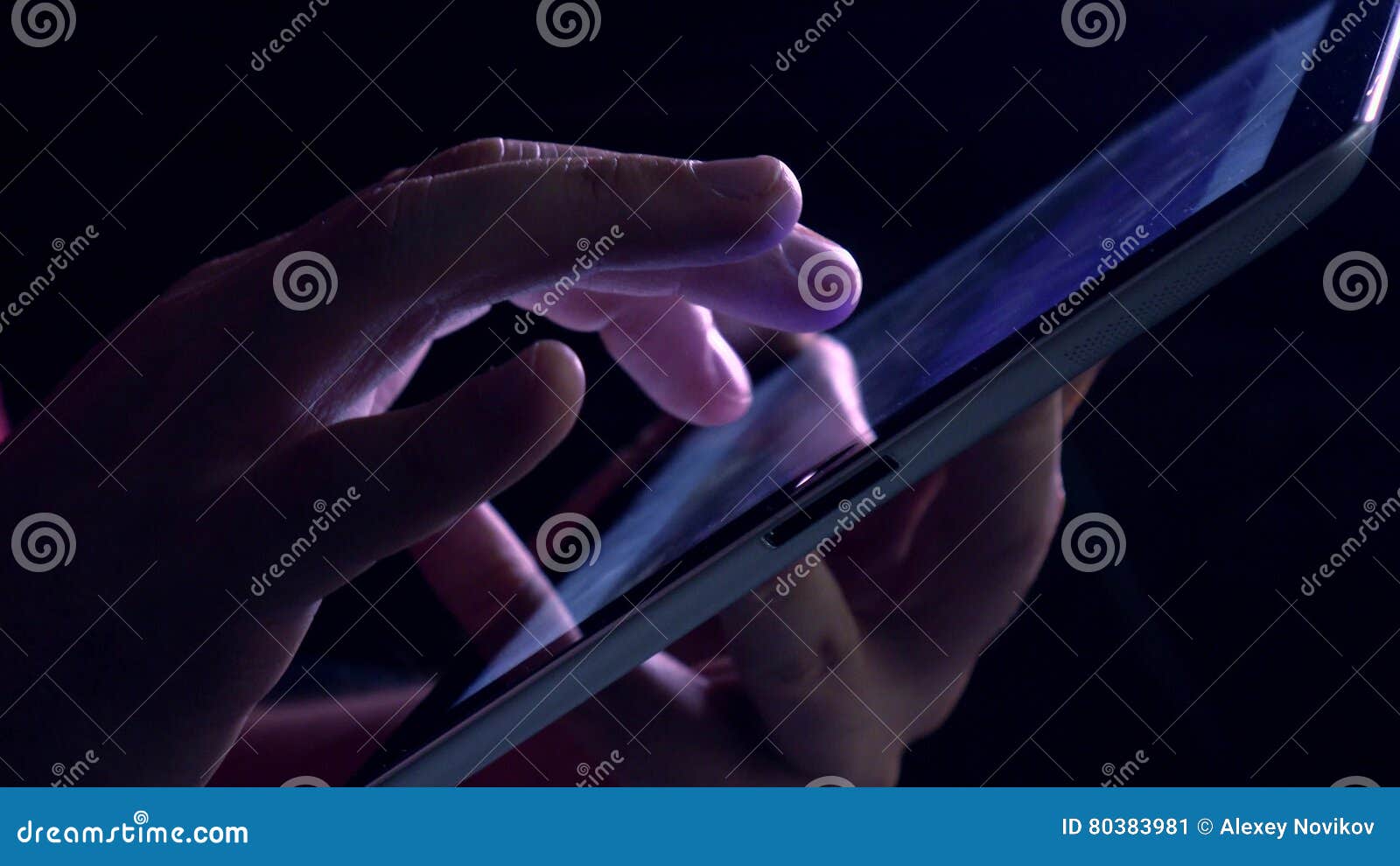 Hand Gestures Over Tablet Computer in Dark Room. Purple Glowing ...