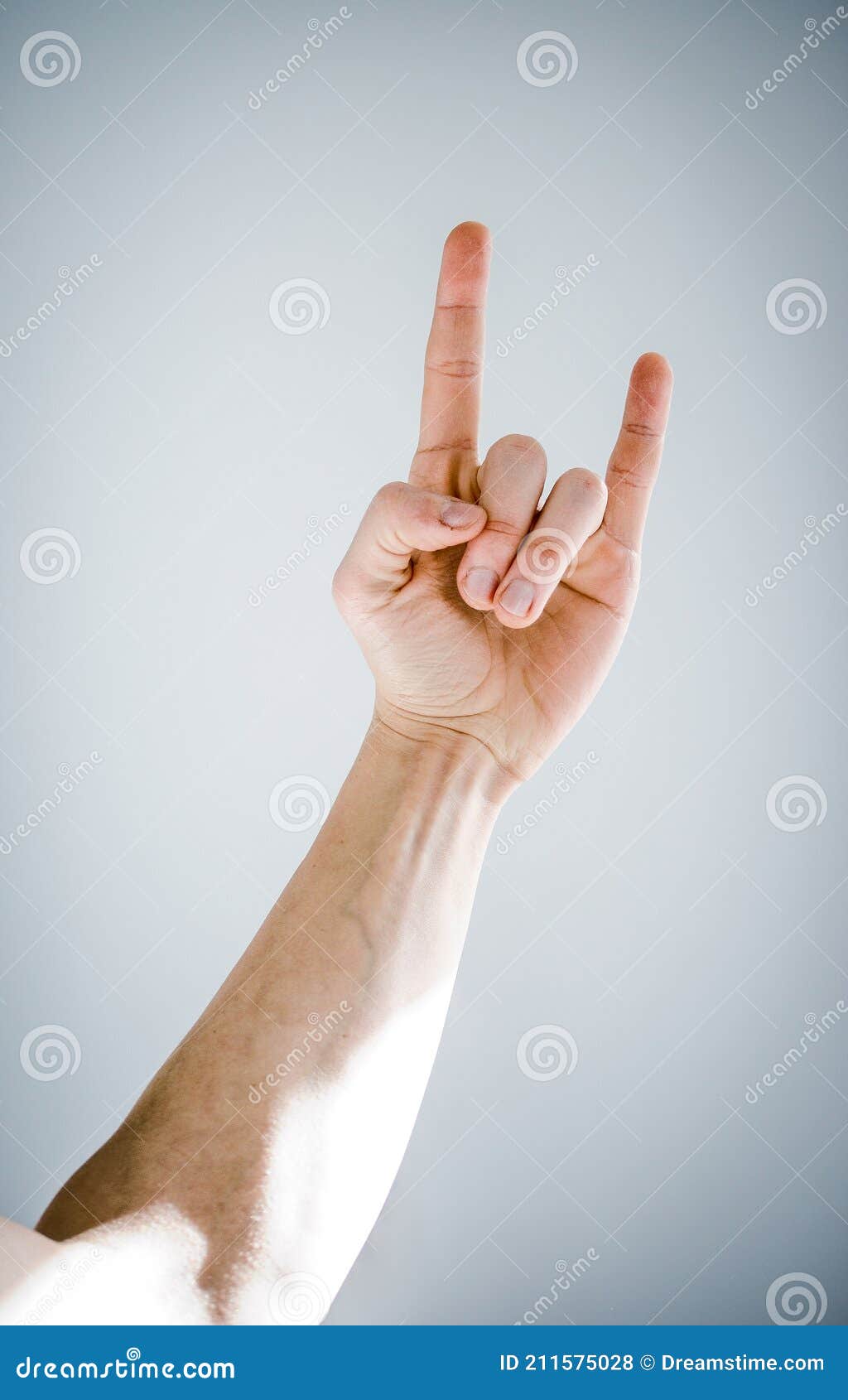 Hand Giving the Devil Horns Gesture Stock Photo - Image of body, human ...