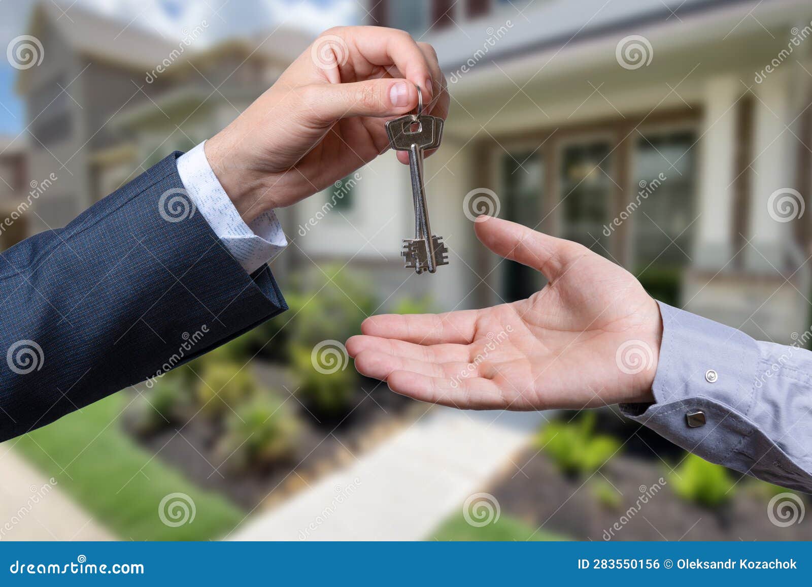 A Hand Giving a Key To Another Hand. House in the Background. Stock ...