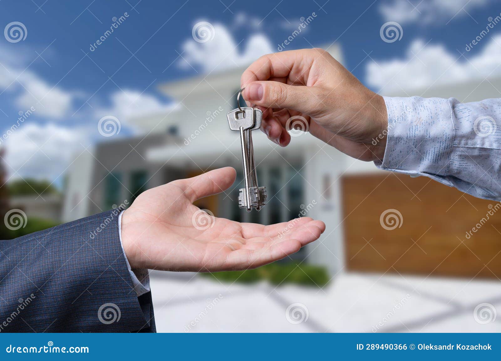 A Hand Giving a Key To Another Hand. House in the Background. Stock ...